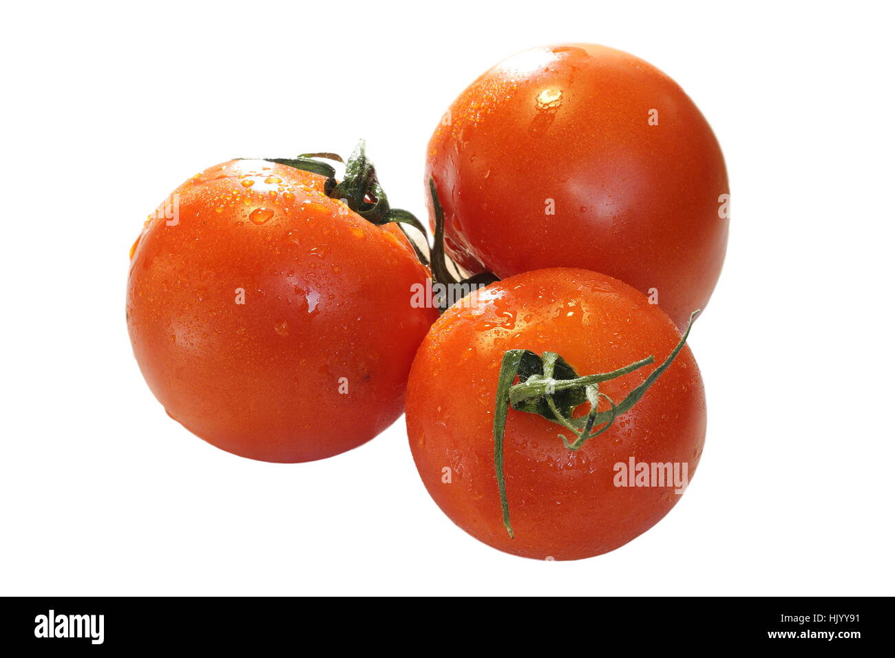 three fresh tomatoes isolated over white background Stock Photo - Alamy