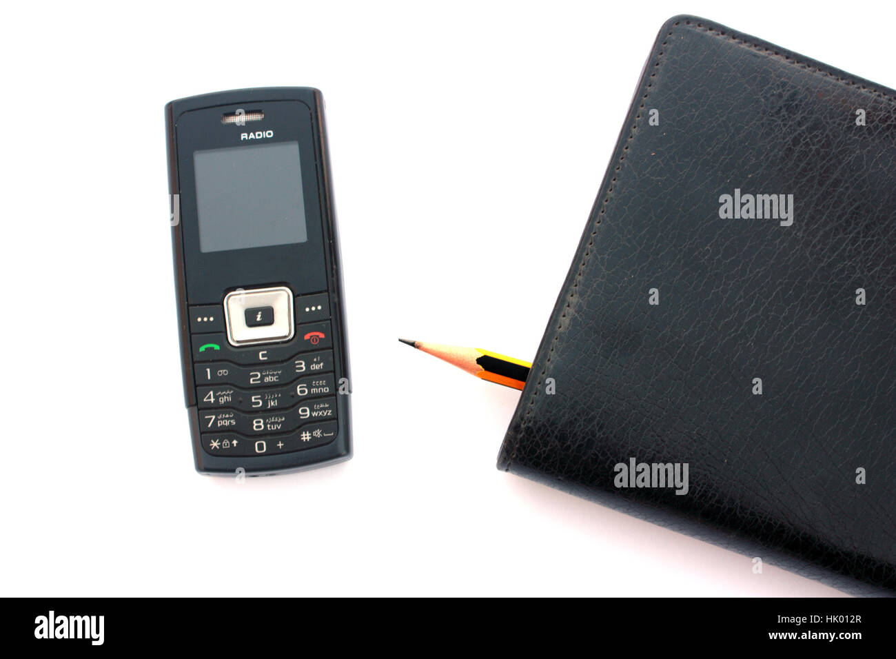 Cellphone and diary on white ground Stock Photo - Alamy