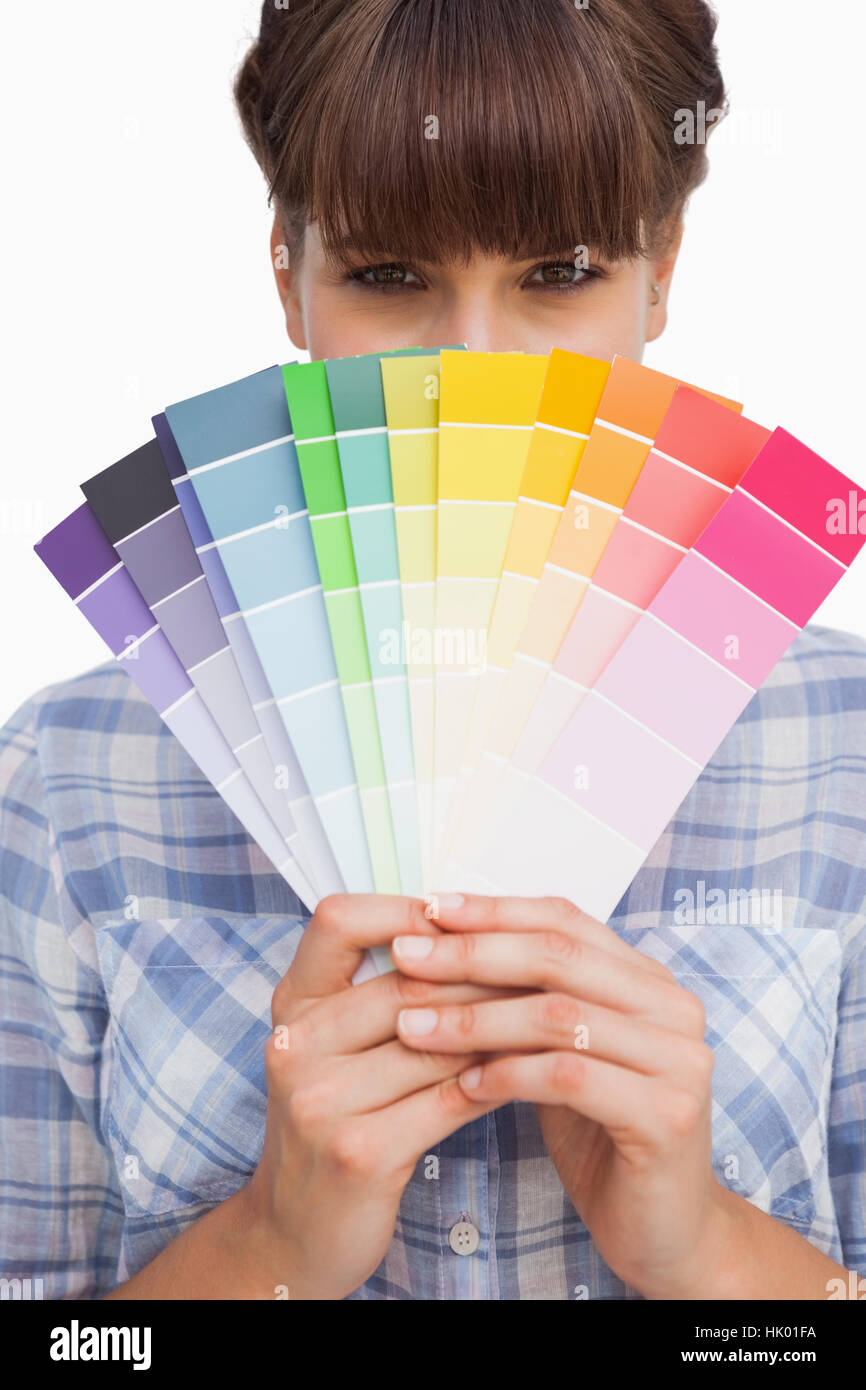 Pretty girl hiding face with colour charts on white background Stock ...