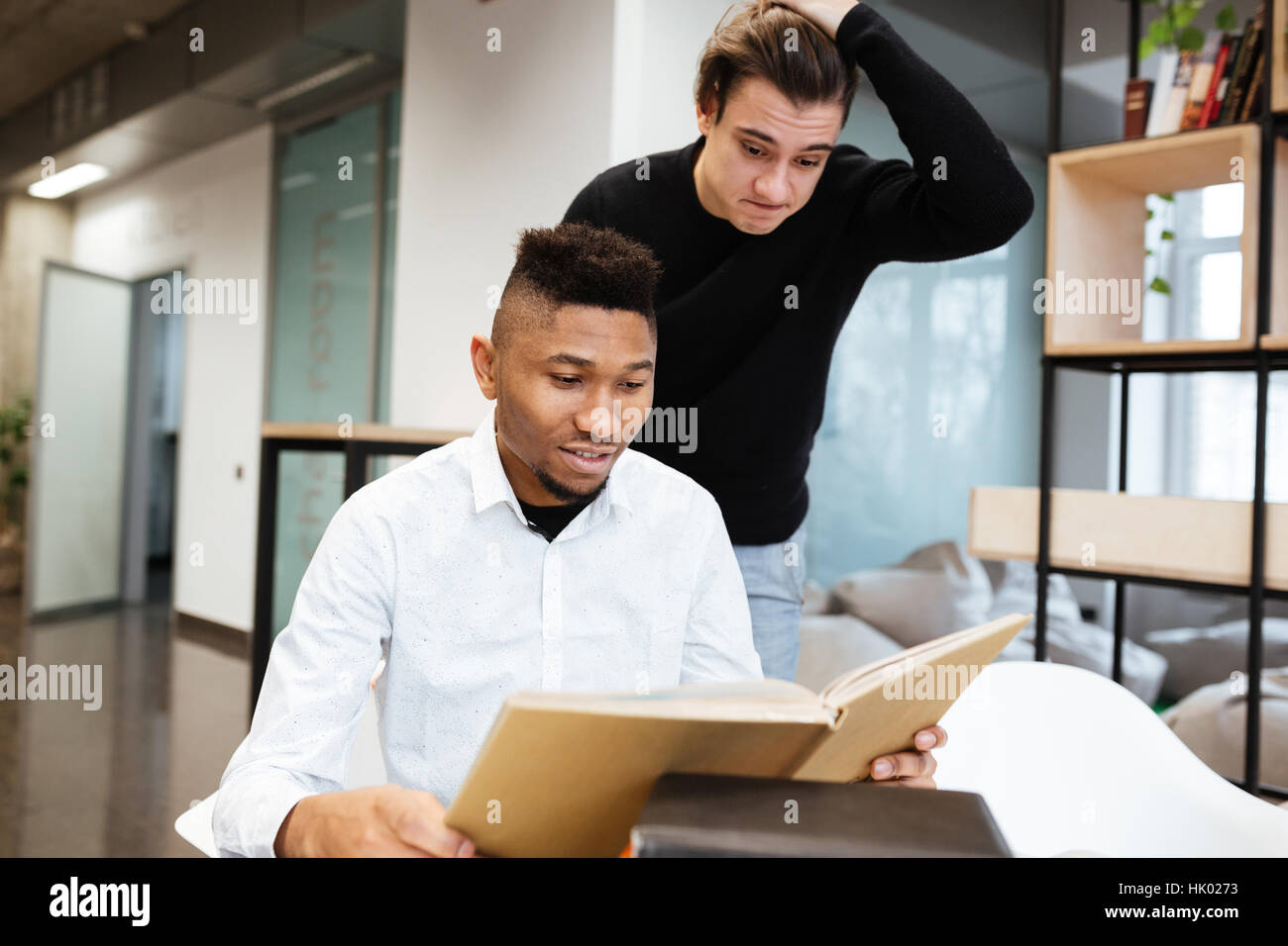 Image of two young confused students in library learning education ...