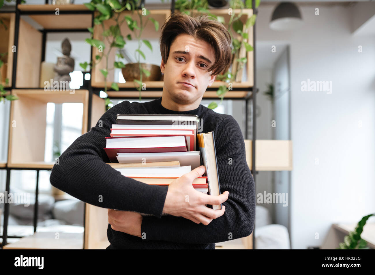 Photo of confused caucasian student in library learning education ...