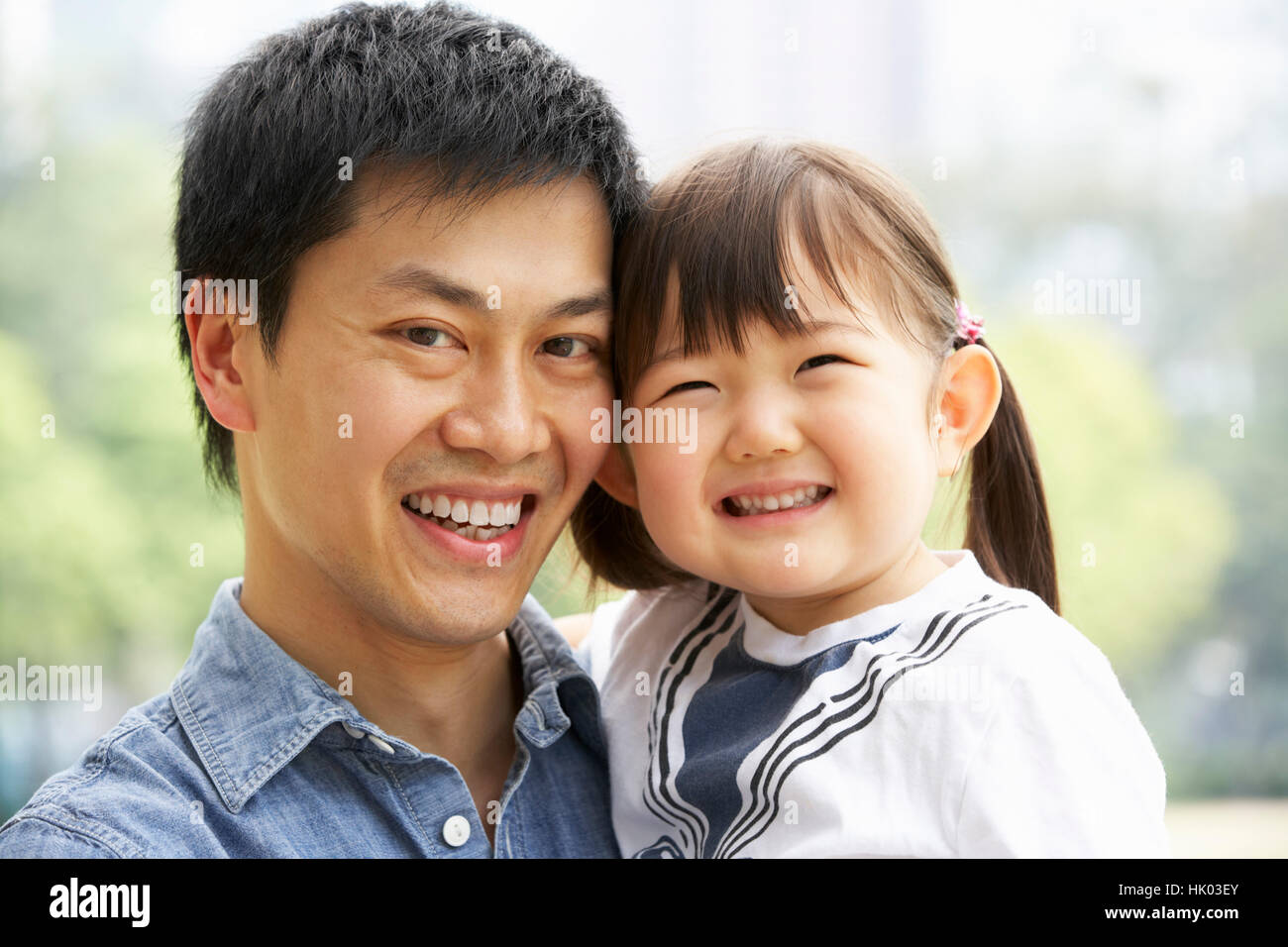 Portrait Of Chinese Father With Daughter In Park Stock Photo - Alamy