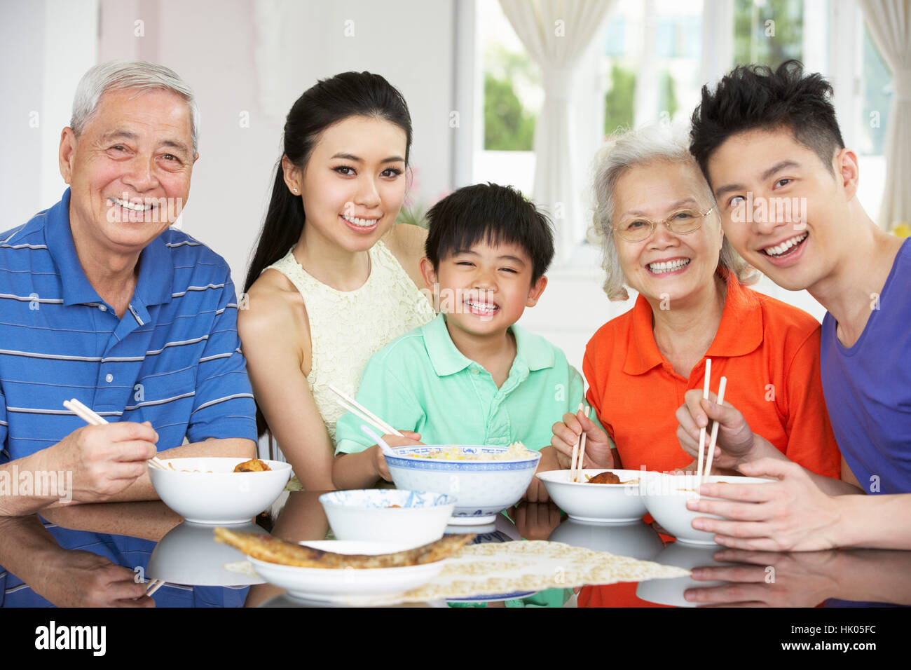 Portrait Of Multi-Generation Chinese Family Eating Meal Together Stock ...