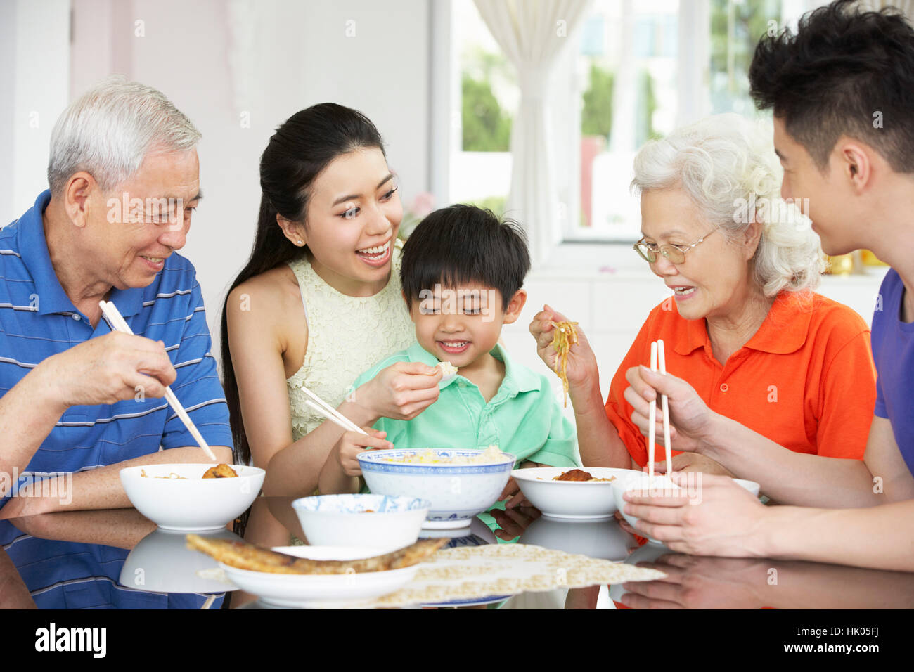Portrait Of Multi-Generation Chinese Family Eating Meal Together Stock ...