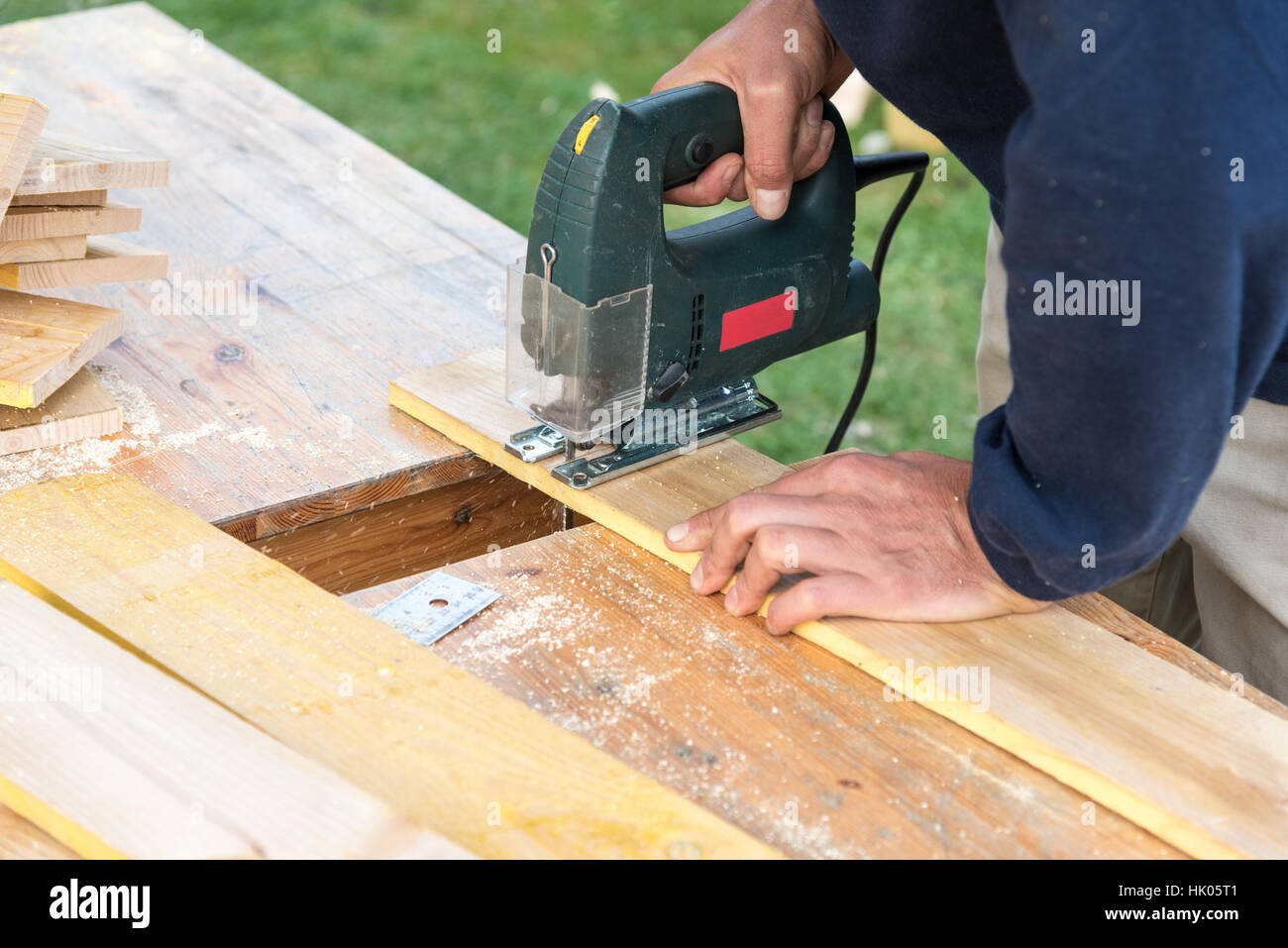 man's hand using electric jigsaw Stock Photo - Alamy
