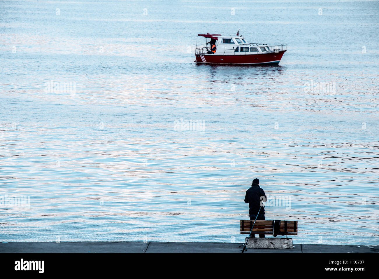 Fisherman by the sea fishing boat in the waters of the sea Stock Photo ...