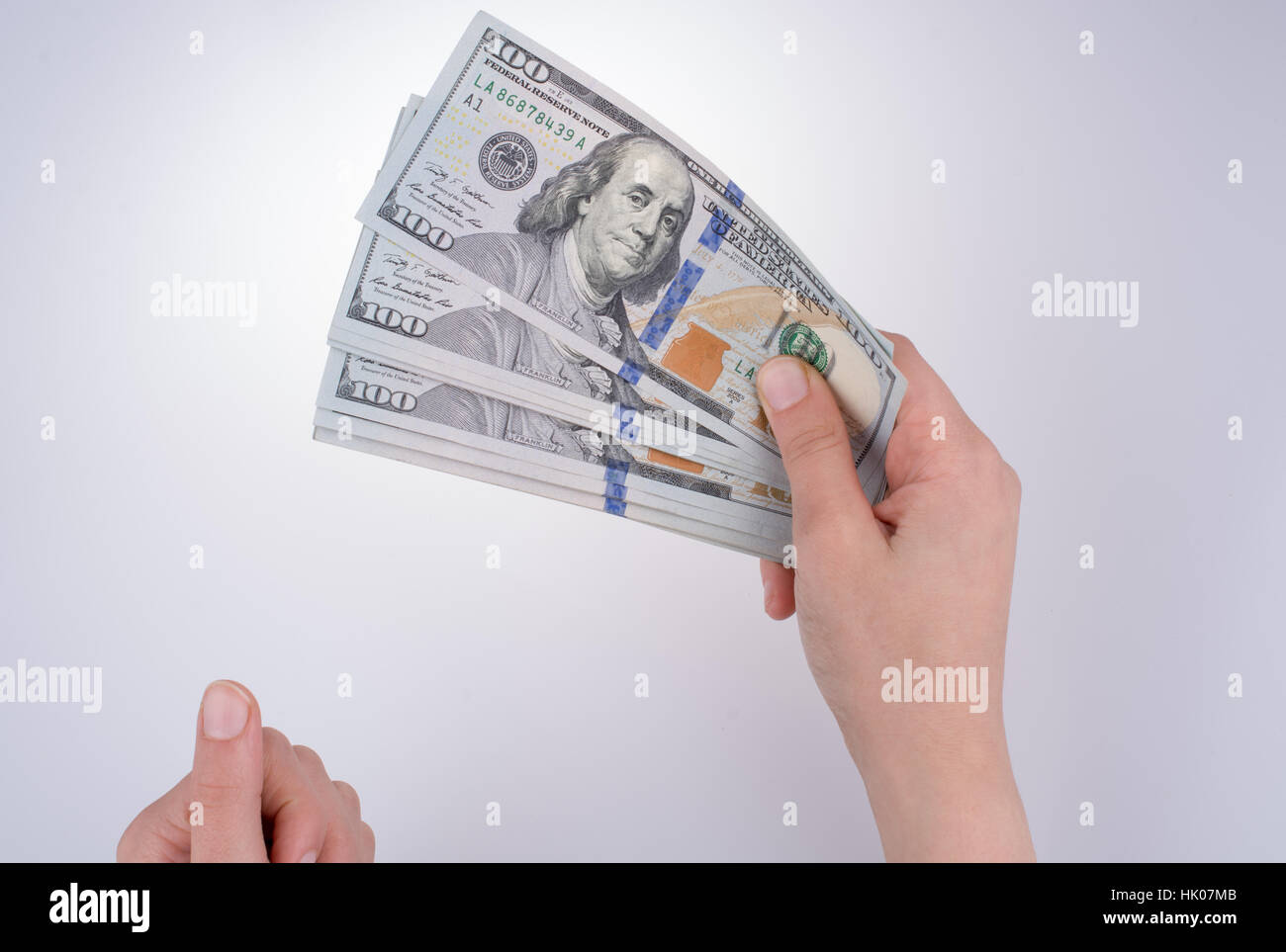 Human hand holding American dollar bill as money isolated on white ...