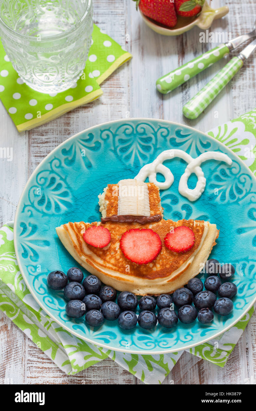 Ship boat pancake with berries for kids breakfast Stock Photo - Alamy