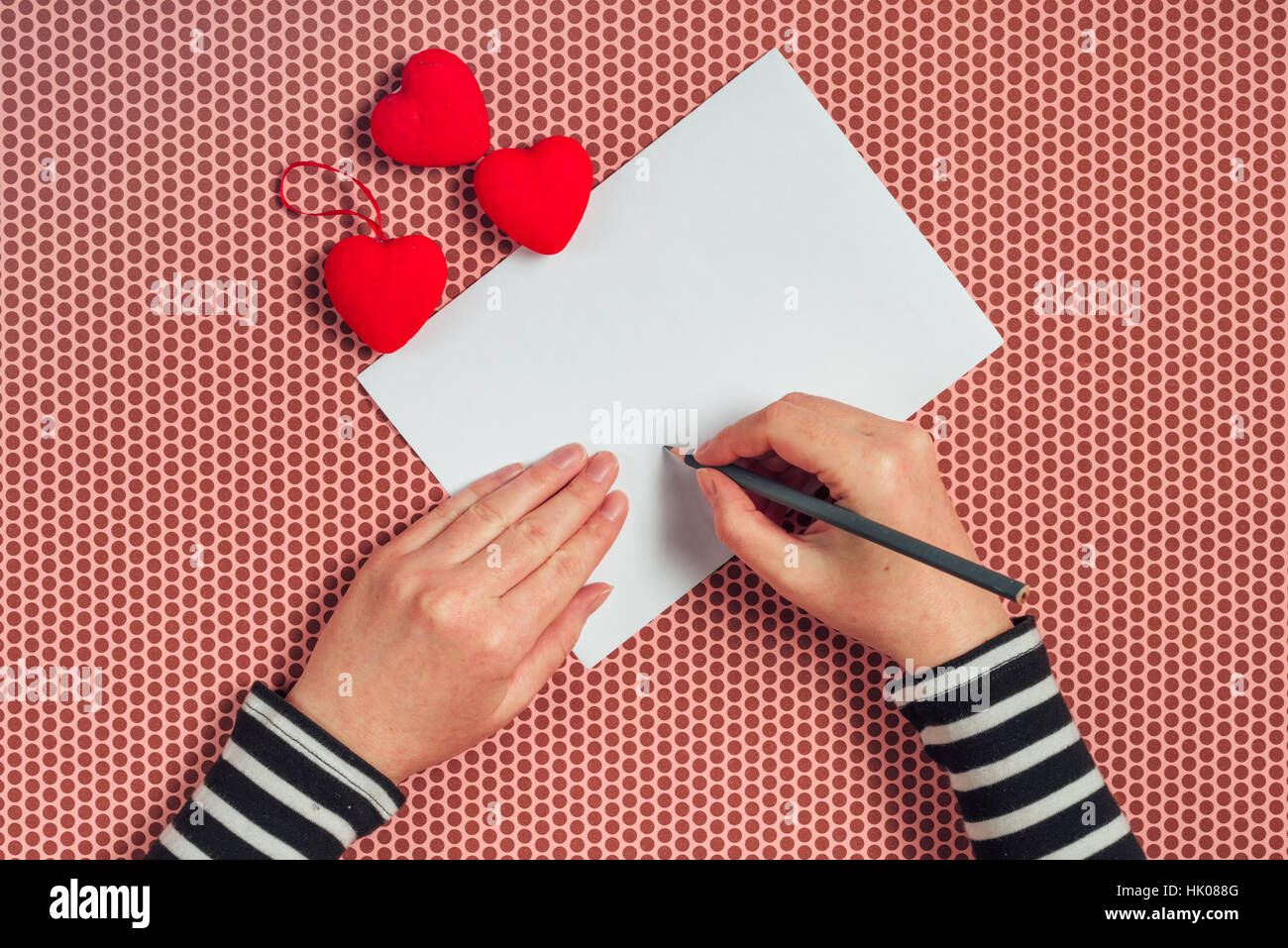 Woman writing love letter or romantic poem for Valentines day, top view ...