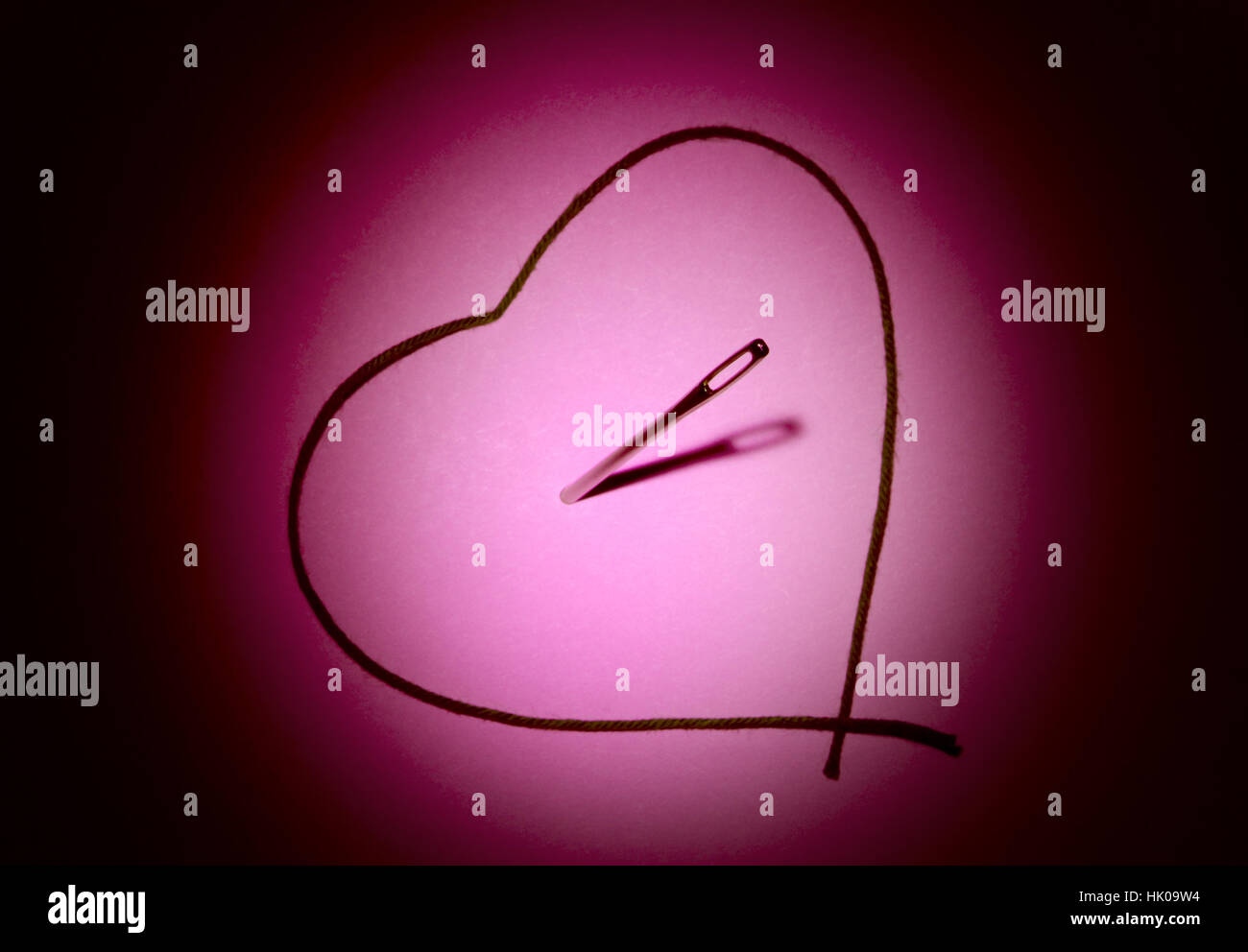 Thread and needle (in the form of heart). A beautiful art background ...