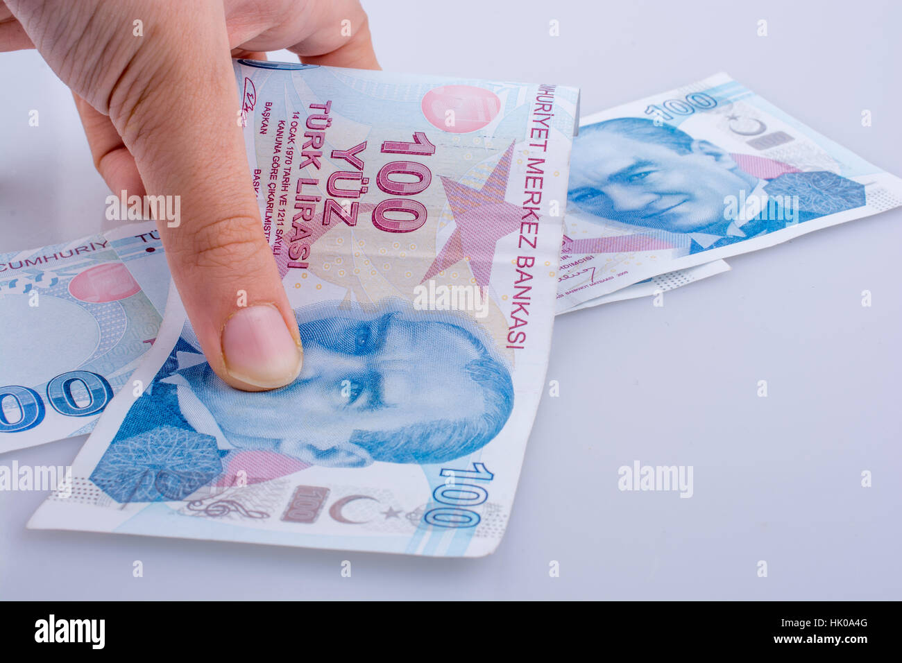 Hand holding 100 Turksh Lira banknotes on white background Stock Photo ...