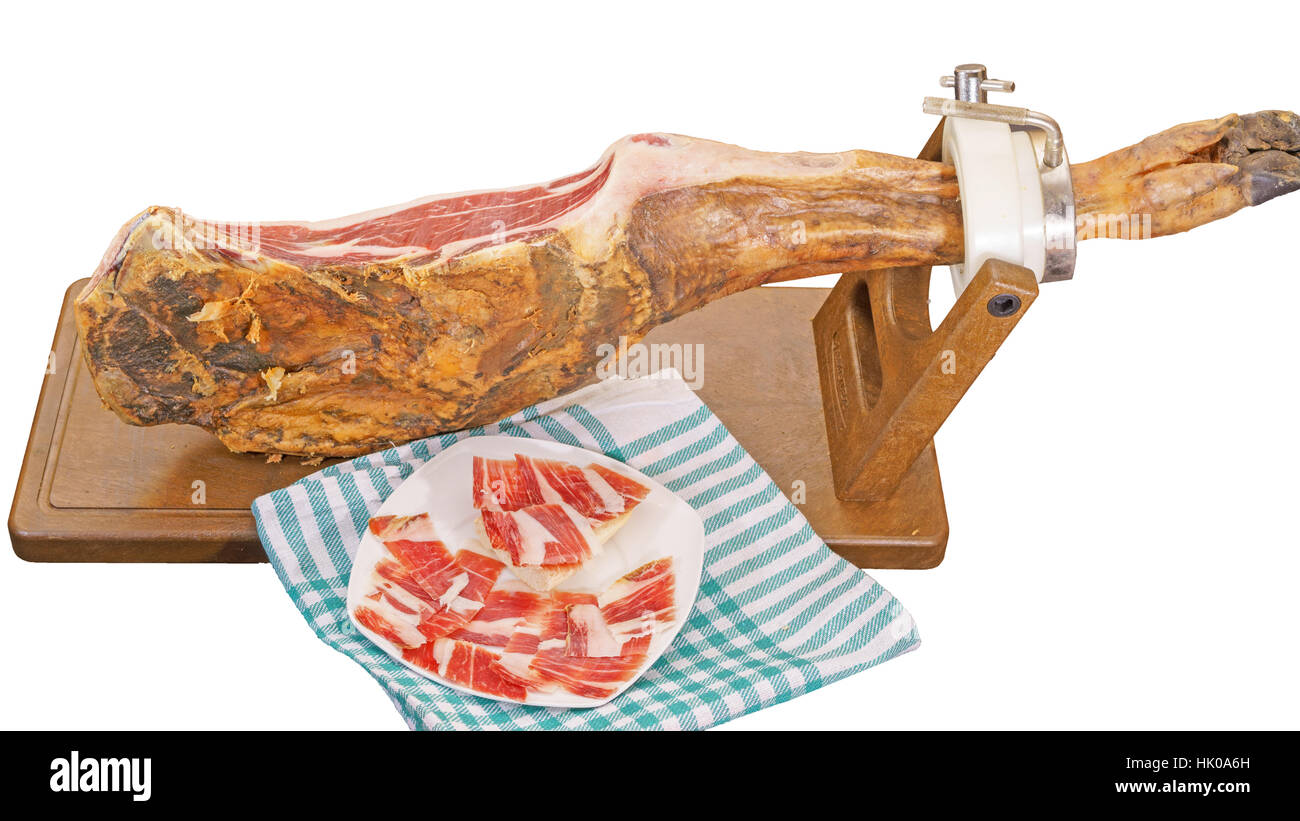 Whole Serrano ham leg with plate and tablecloth Stock Photo - Alamy