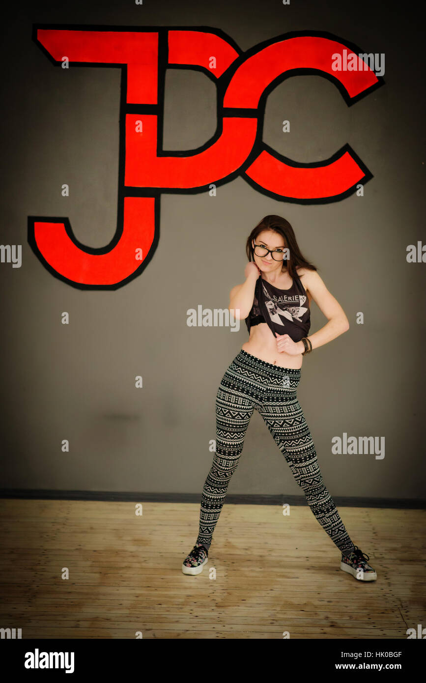 Brunette street dancer girl wearing casual clothes background gray wall ...