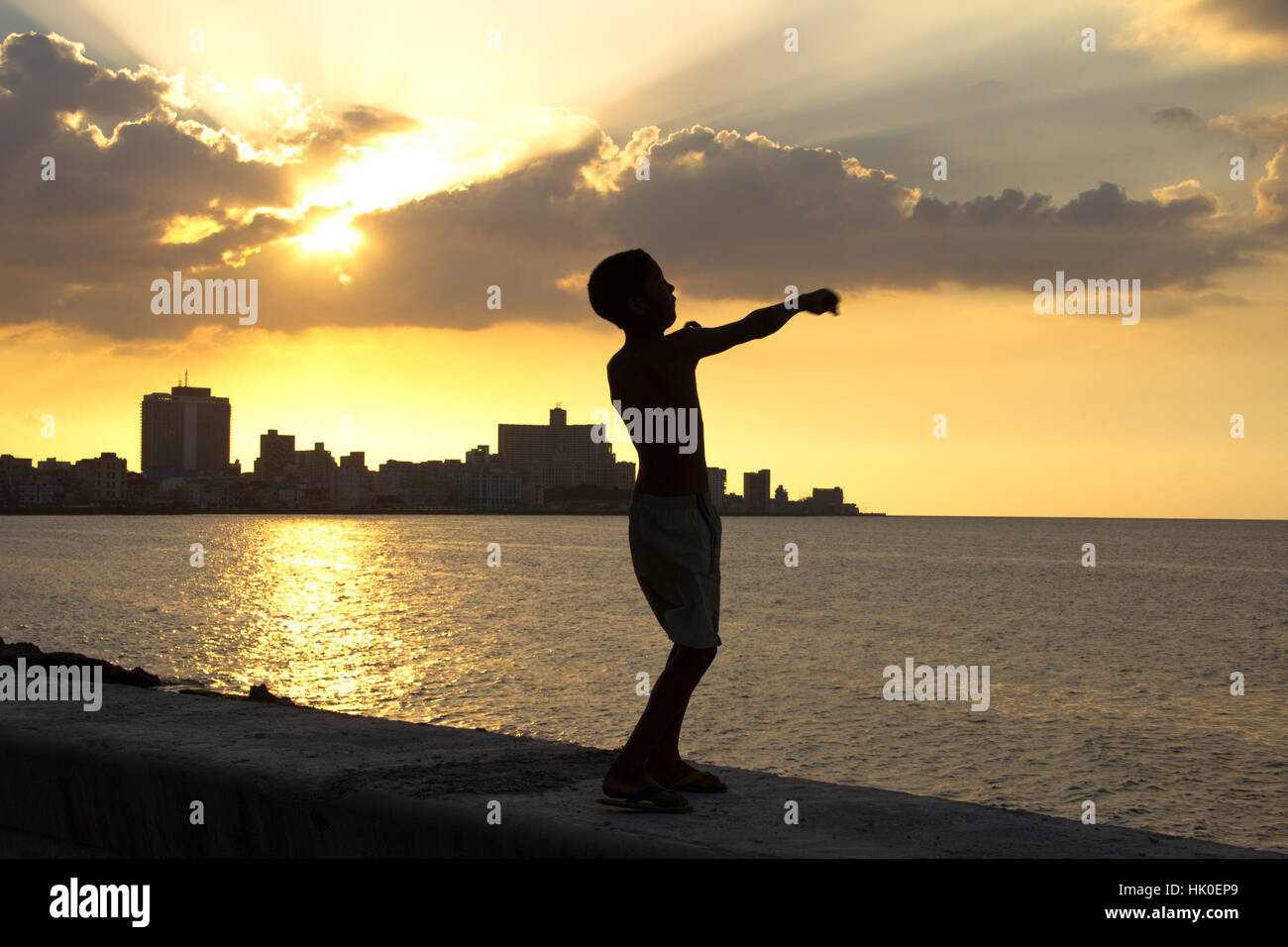 Child throwing stones in water hi-res stock photography and images - Alamy