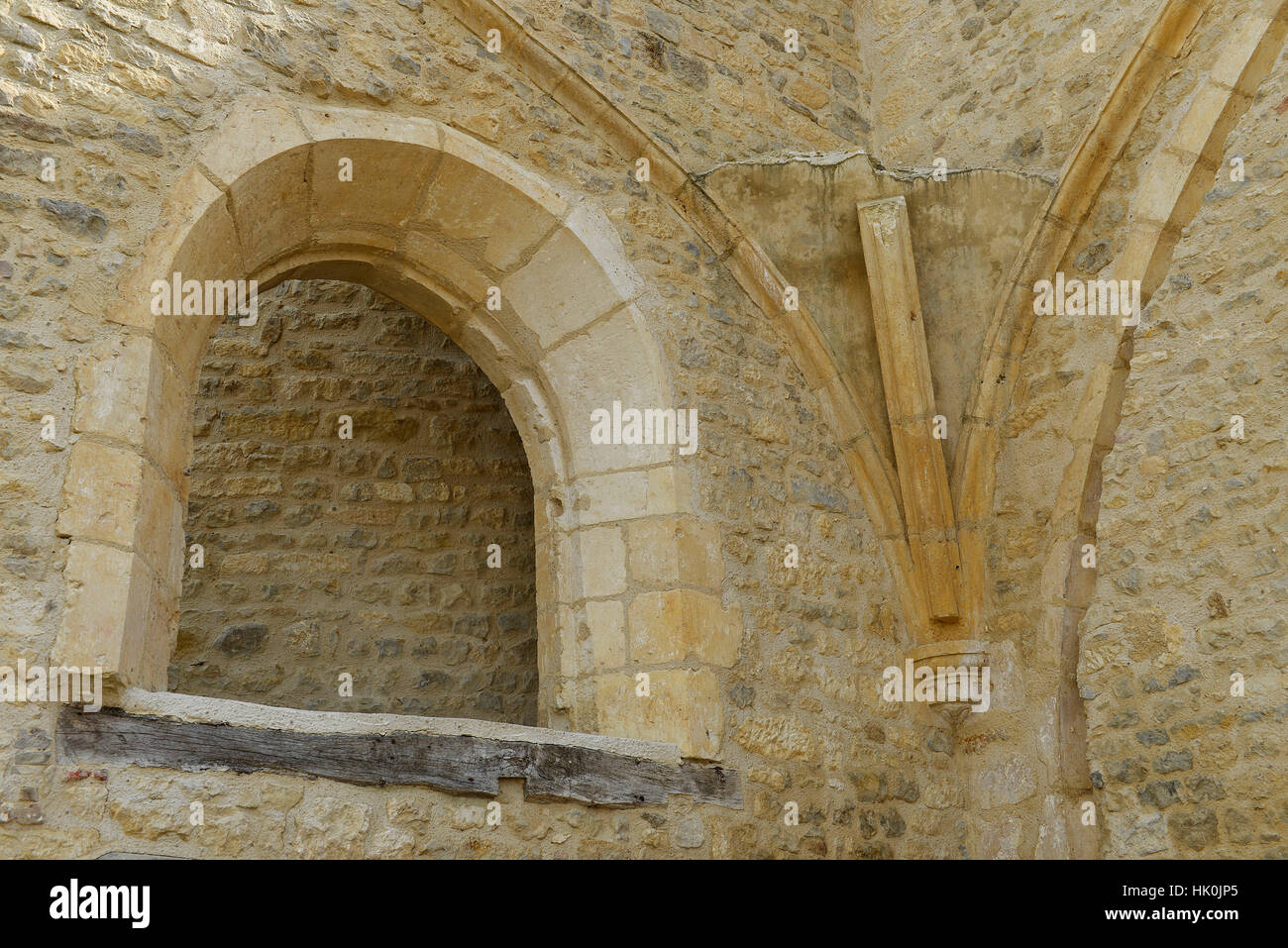 France, medieval stone wall with a window and a start of a vault in the ...