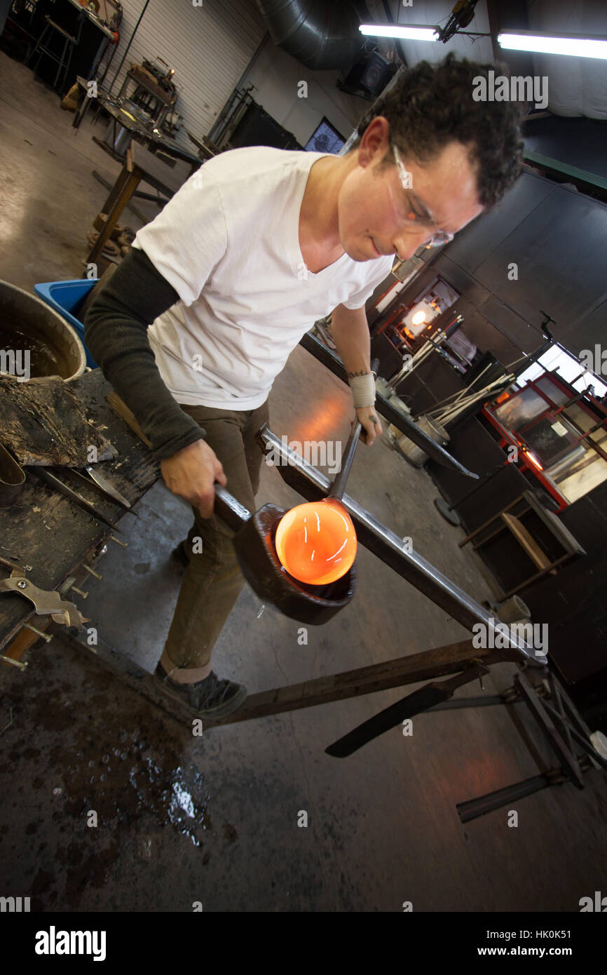 Small business glass manufacturer forming glowing hot object Stock ...