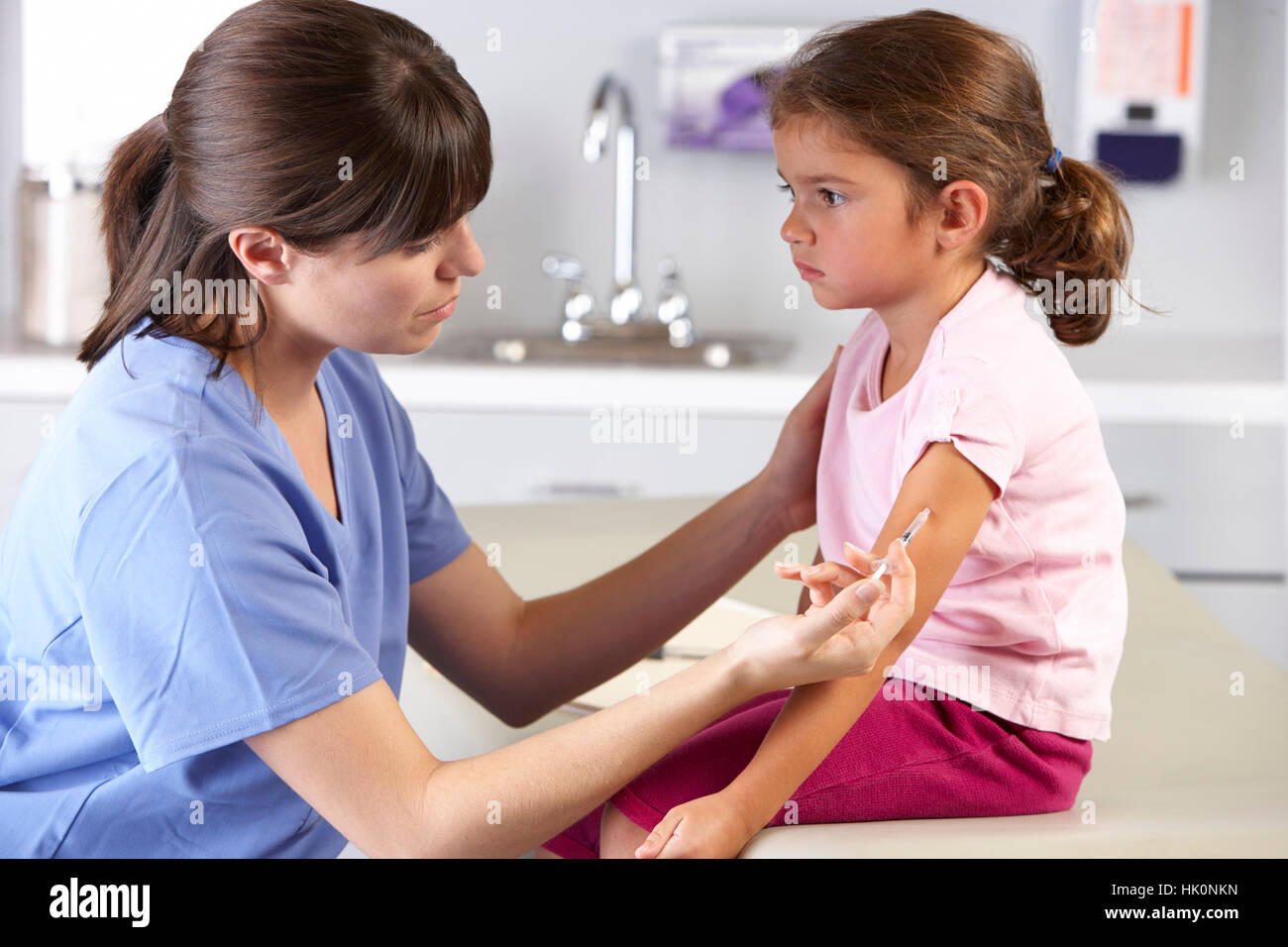 Doctor Giving Child Injection In Doctor's Office Stock Photo - Alamy