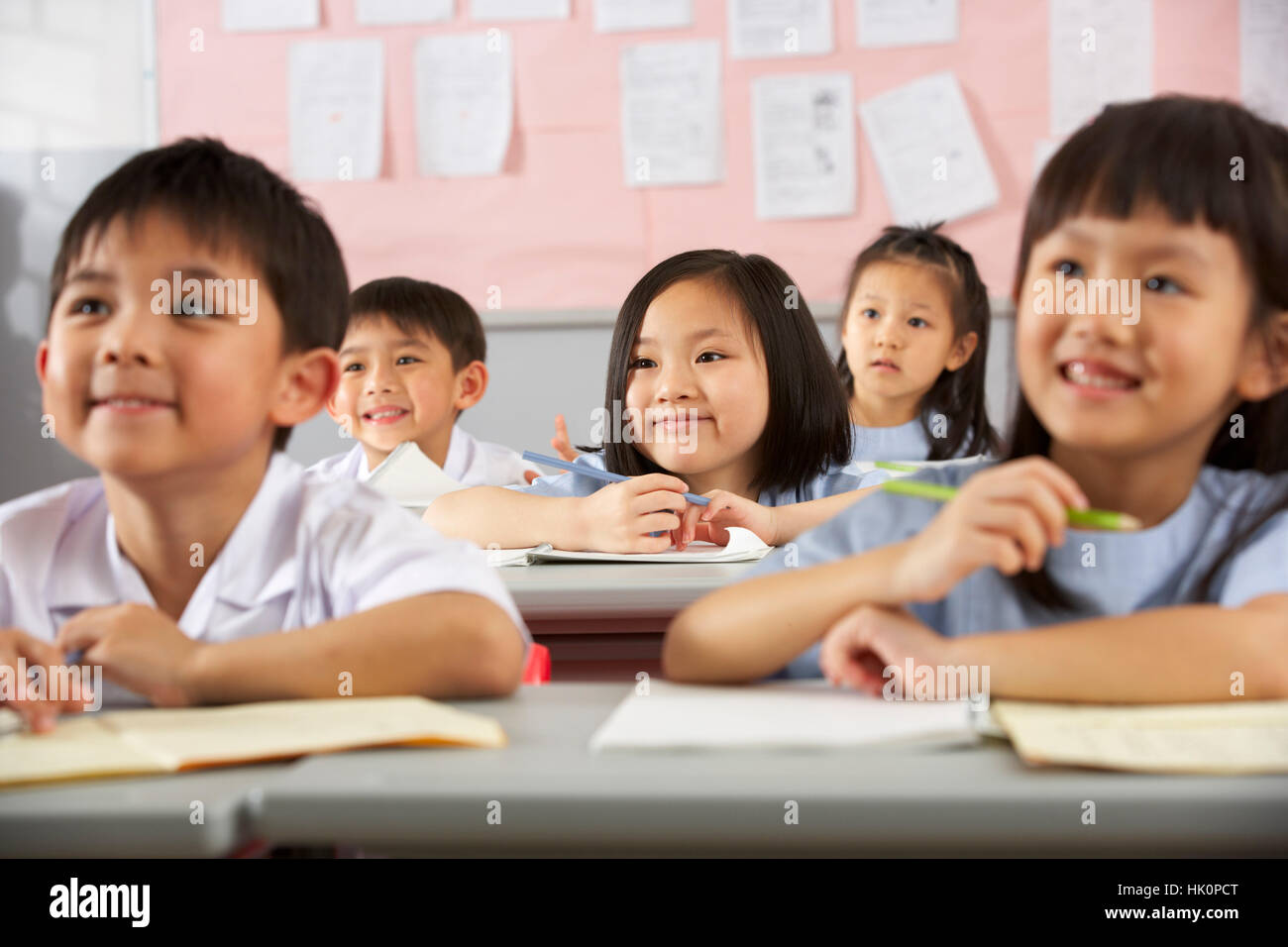 Group Of Students Working At Desks In Chinese School Classroom Stock ...