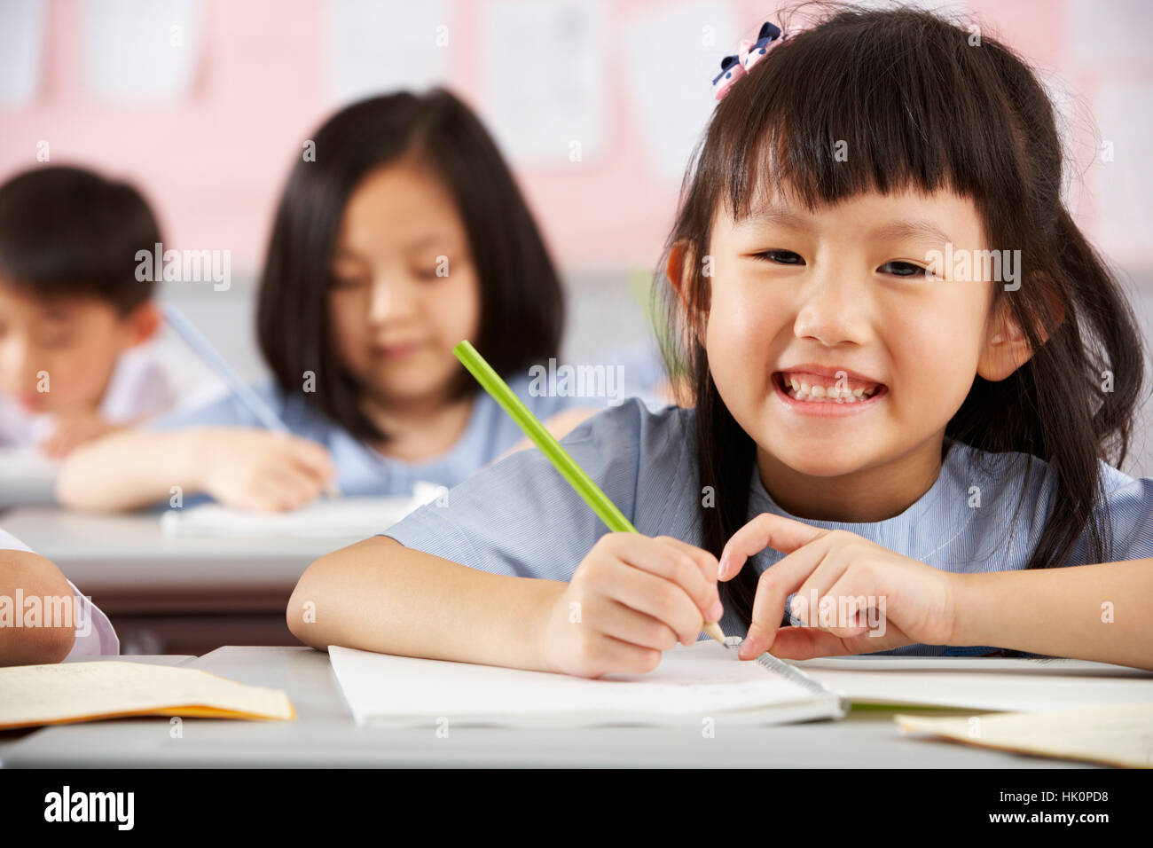 Group Of Students Working At Desks In Chinese School Classroom Stock ...