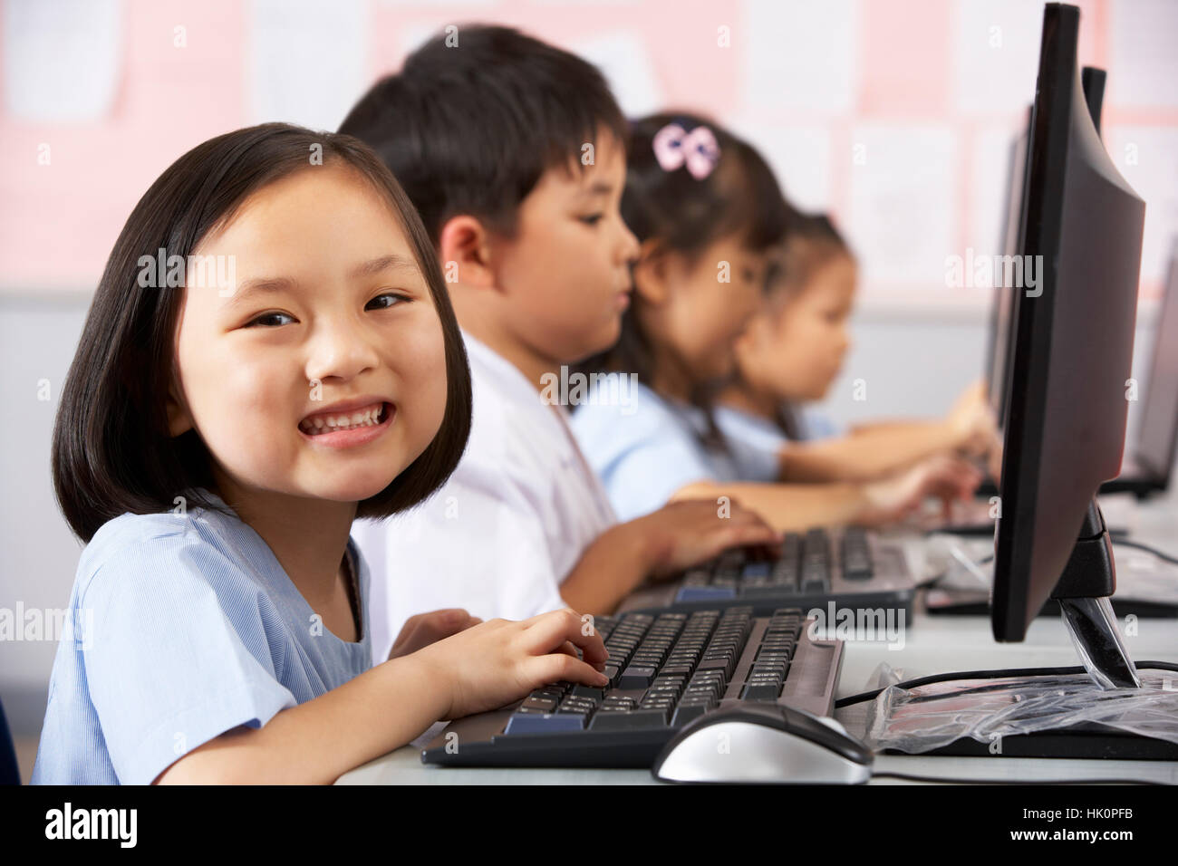 Female Pupil Using Keyboard During Computer Class In Chinese School ...