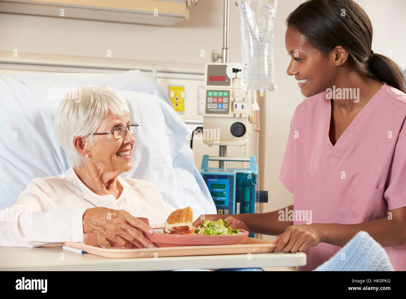 Female nurse serving food patient hi-res stock photography and images ...