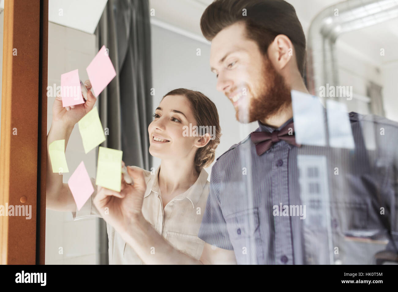 happy creative team writing on stickers at office Stock Photo - Alamy