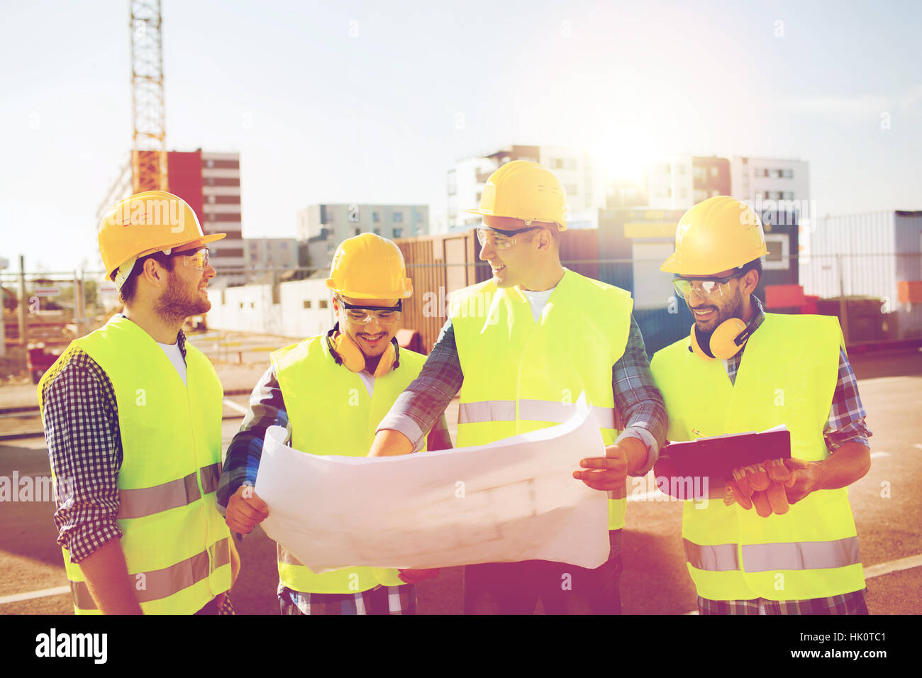 group of builders with tablet pc and blueprint Stock Photo - Alamy