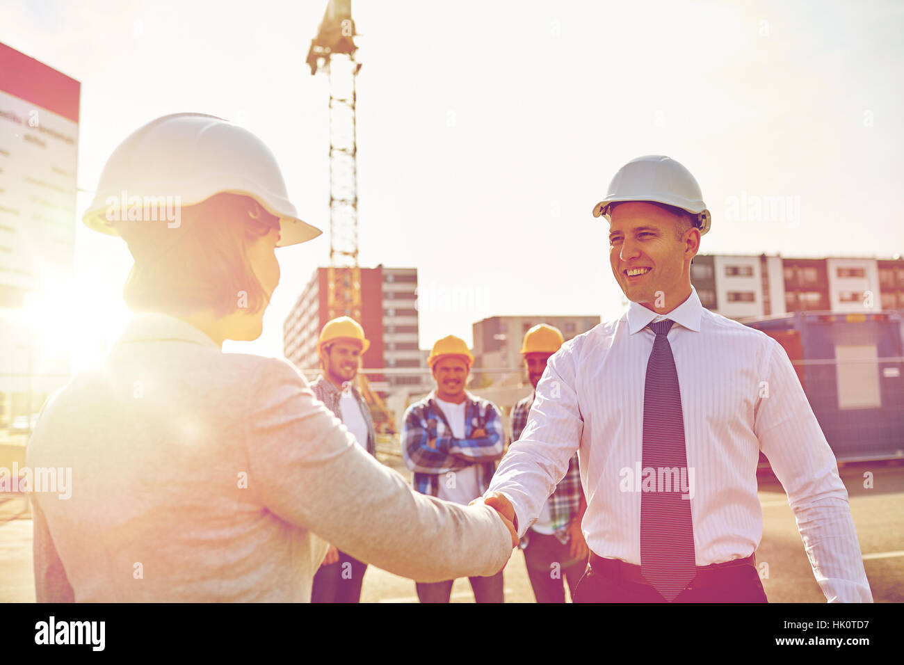 builders making handshake on construction site Stock Photo - Alamy