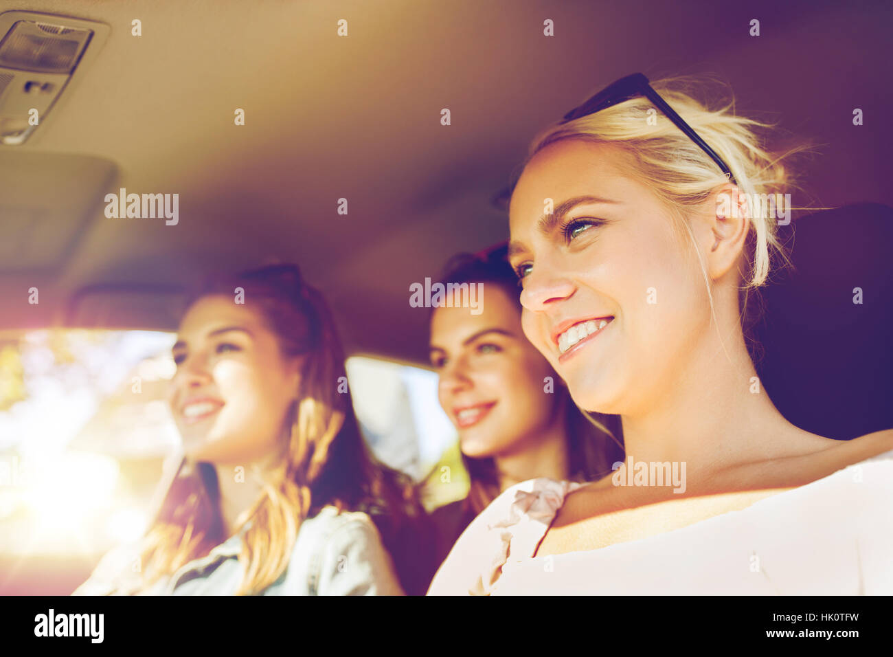 happy teenage girls or young women driving in car Stock Photo - Alamy