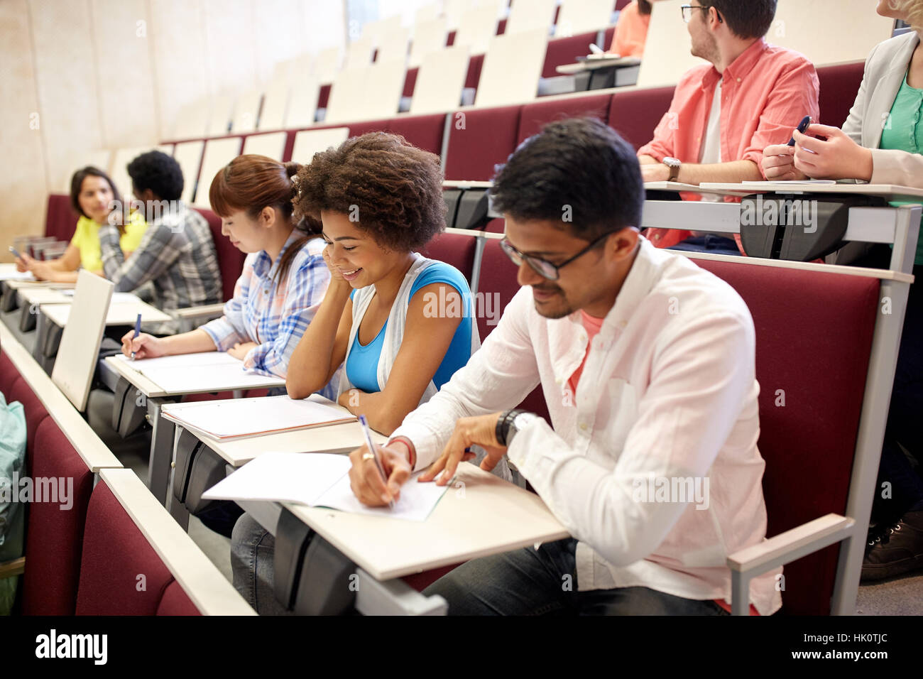 group of students with notebooks in lecture hall Stock Photo - Alamy