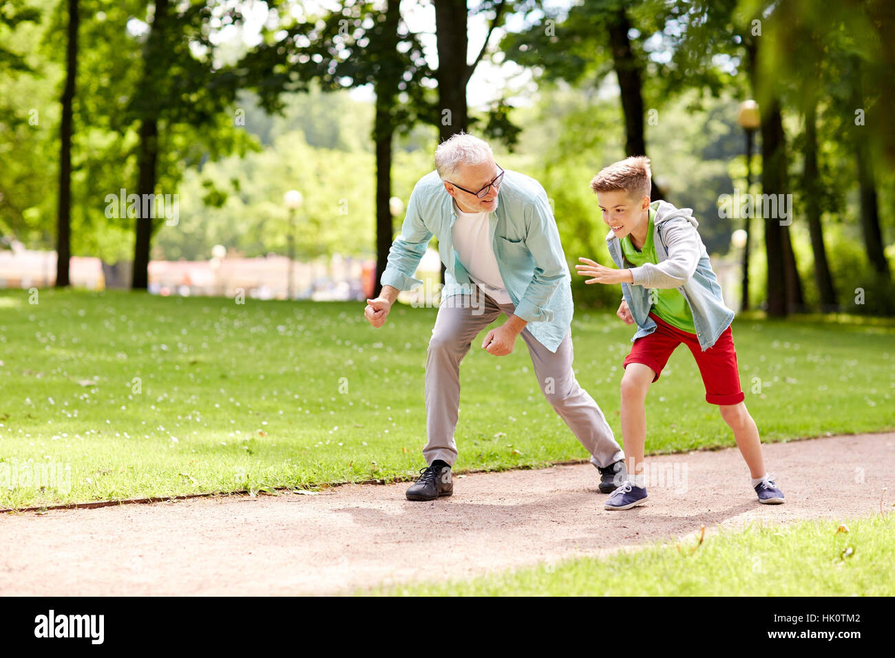 grandfather and grandson racing at summer park Stock Photo - Alamy