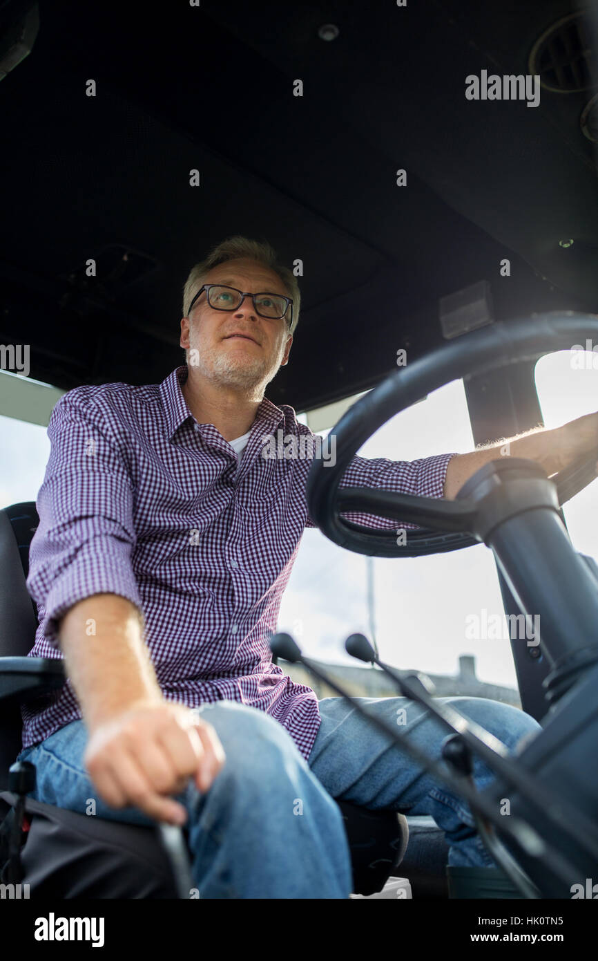 senior man driving tractor at farm Stock Photo - Alamy