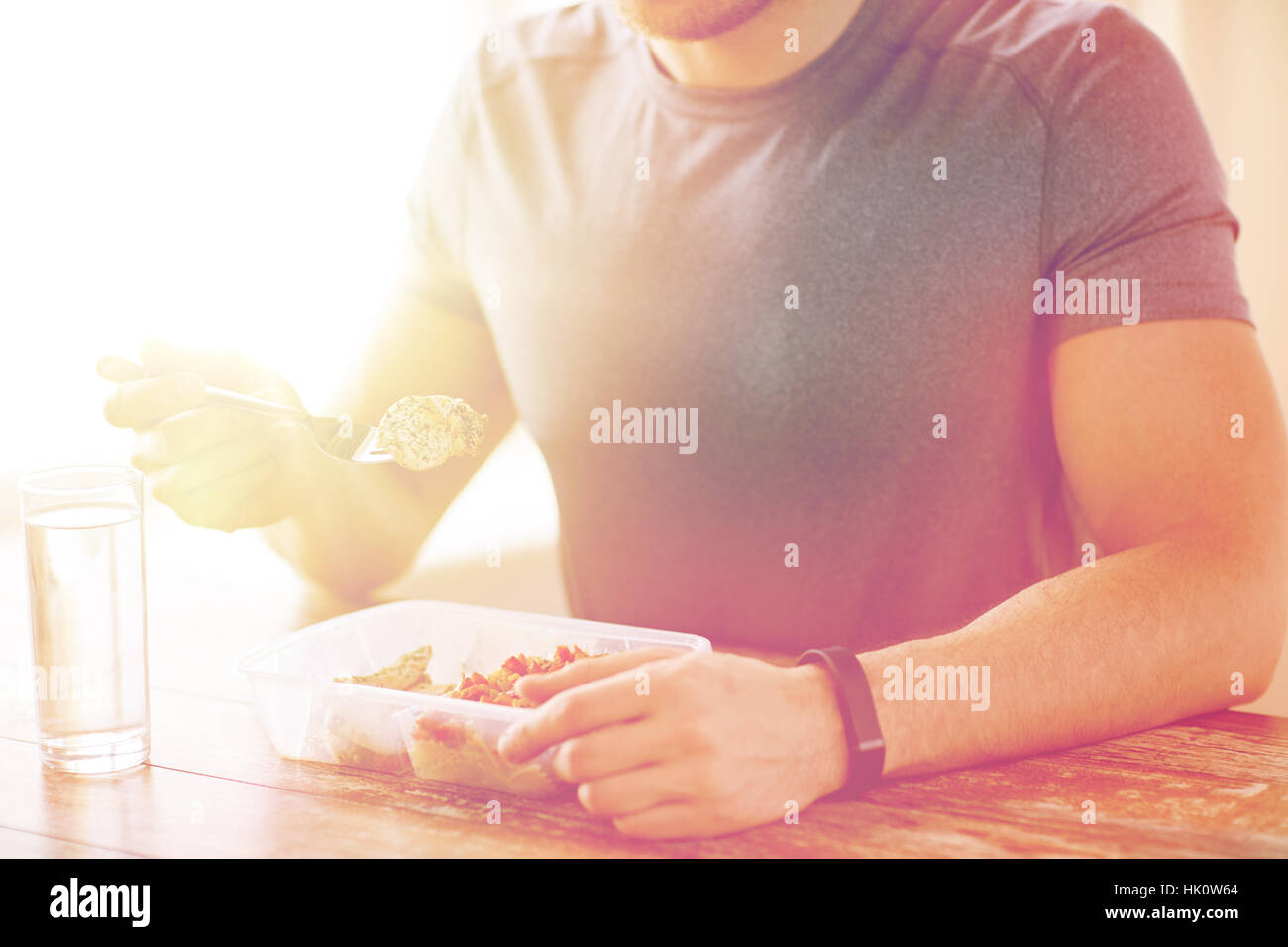 close up of man with fork and water eating food Stock Photo - Alamy