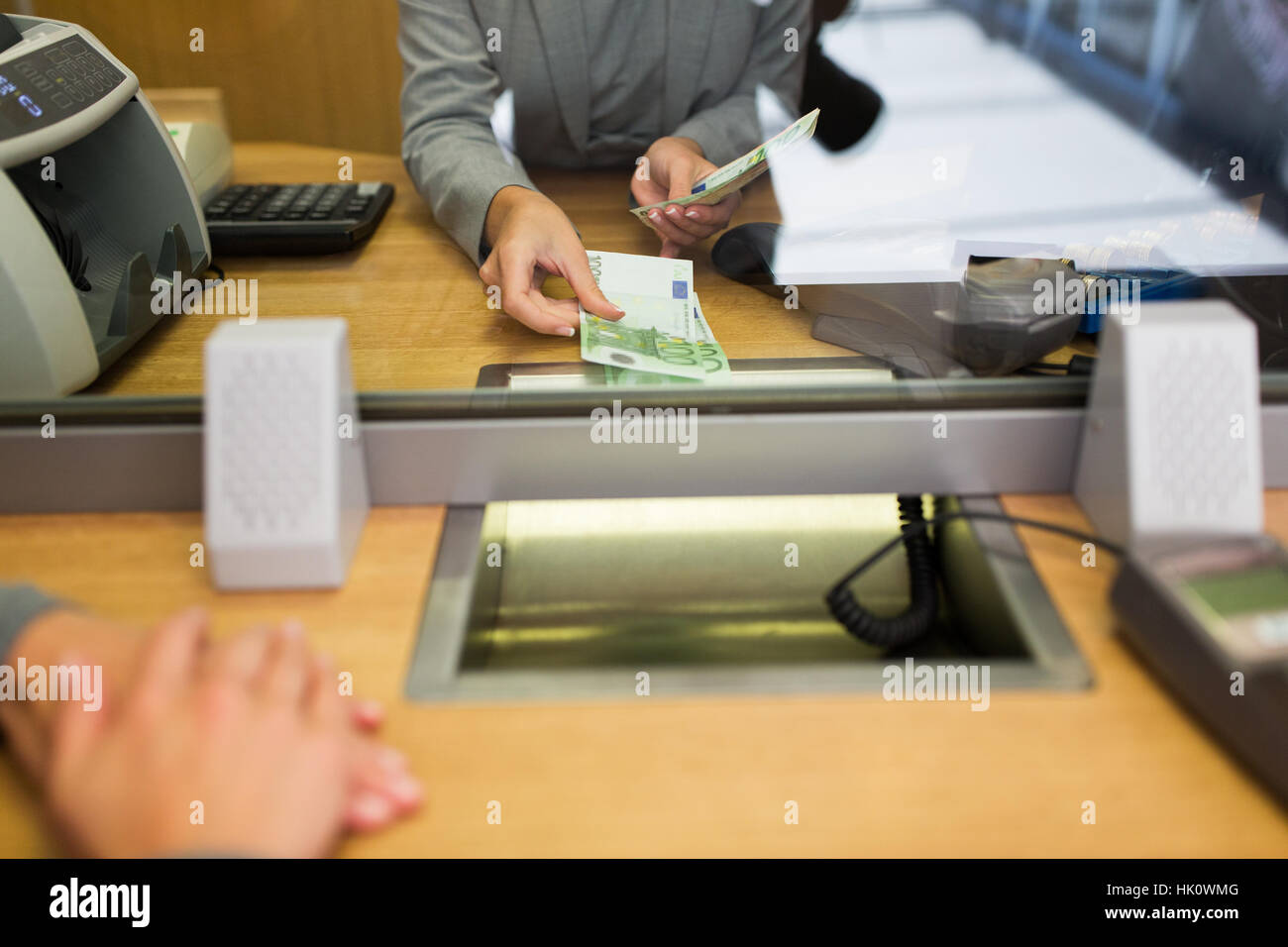 clerk giving cash money to customer at bank office Stock Photo - Alamy