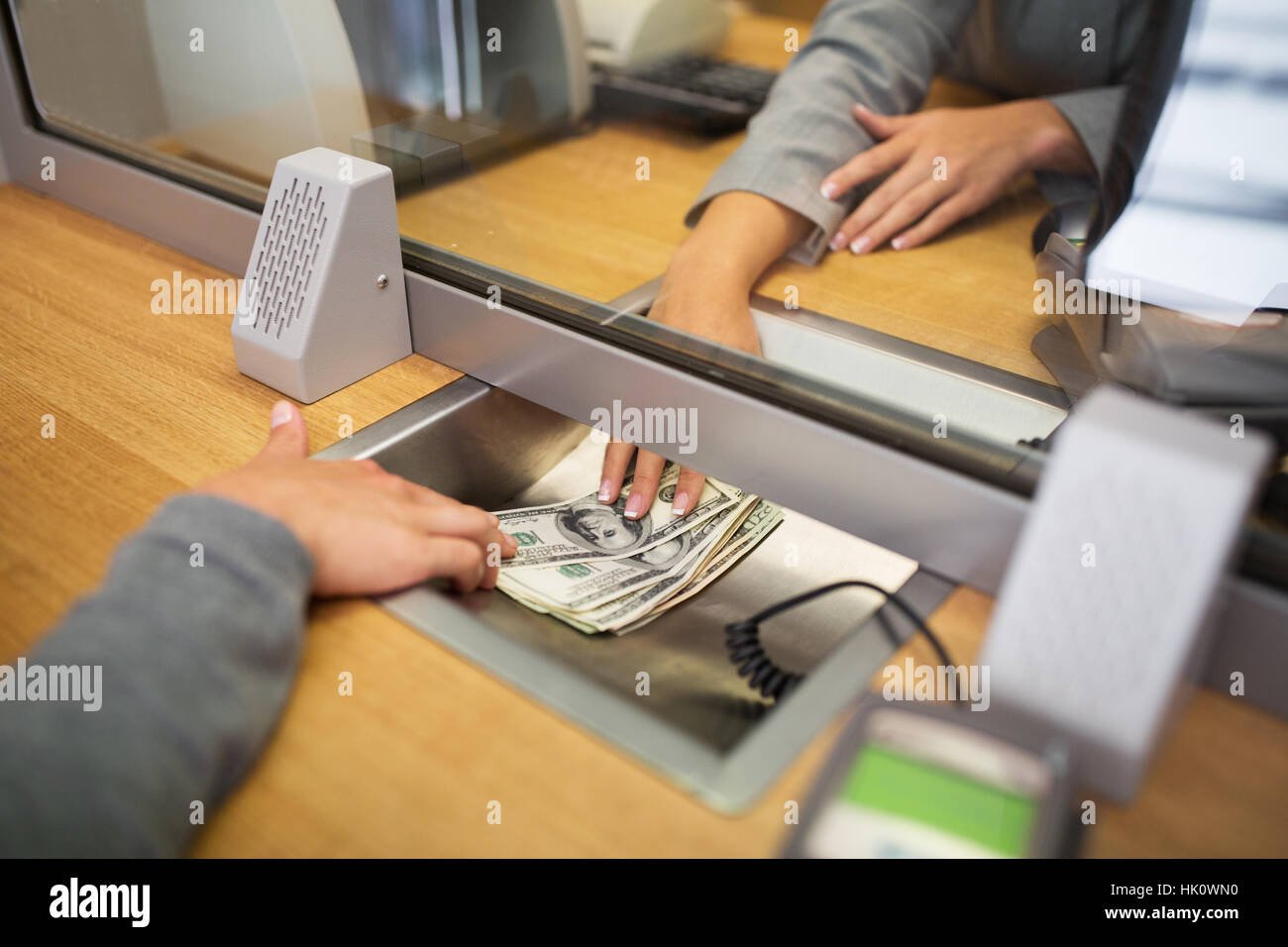 clerk giving cash money to customer at bank office Stock Photo - Alamy