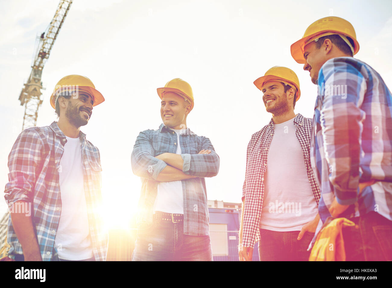 group of smiling builders in hardhats outdoors Stock Photo - Alamy