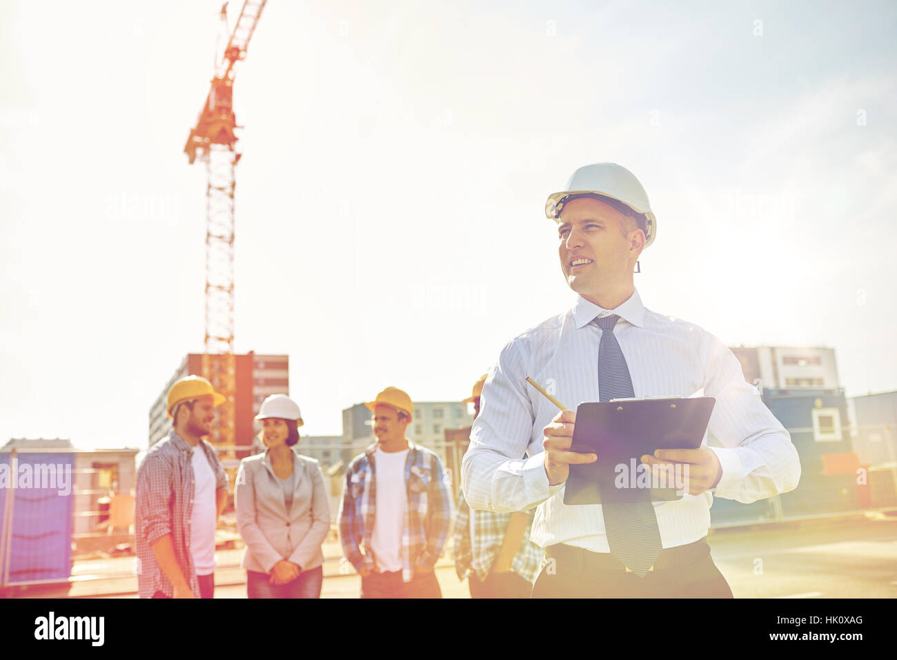 happy builders and architect at construction site Stock Photo - Alamy