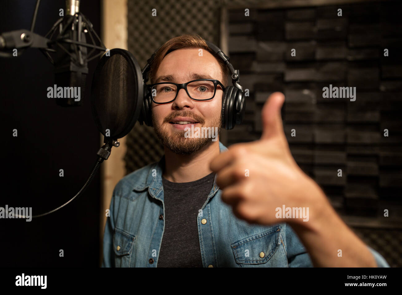 man with headphones singing at recording studio Stock Photo - Alamy