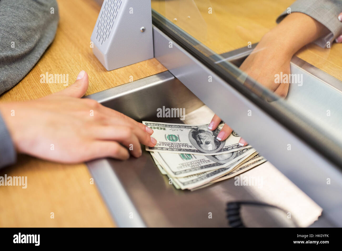 clerk giving cash money to customer at bank office Stock Photo - Alamy