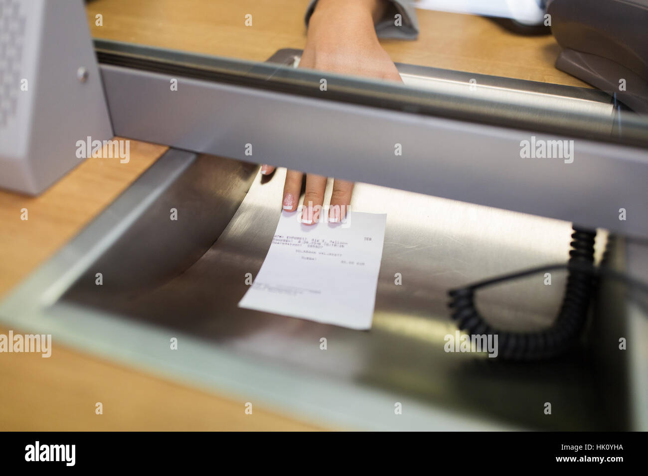 clerk giving receipt at bank or currency exchanger Stock Photo - Alamy