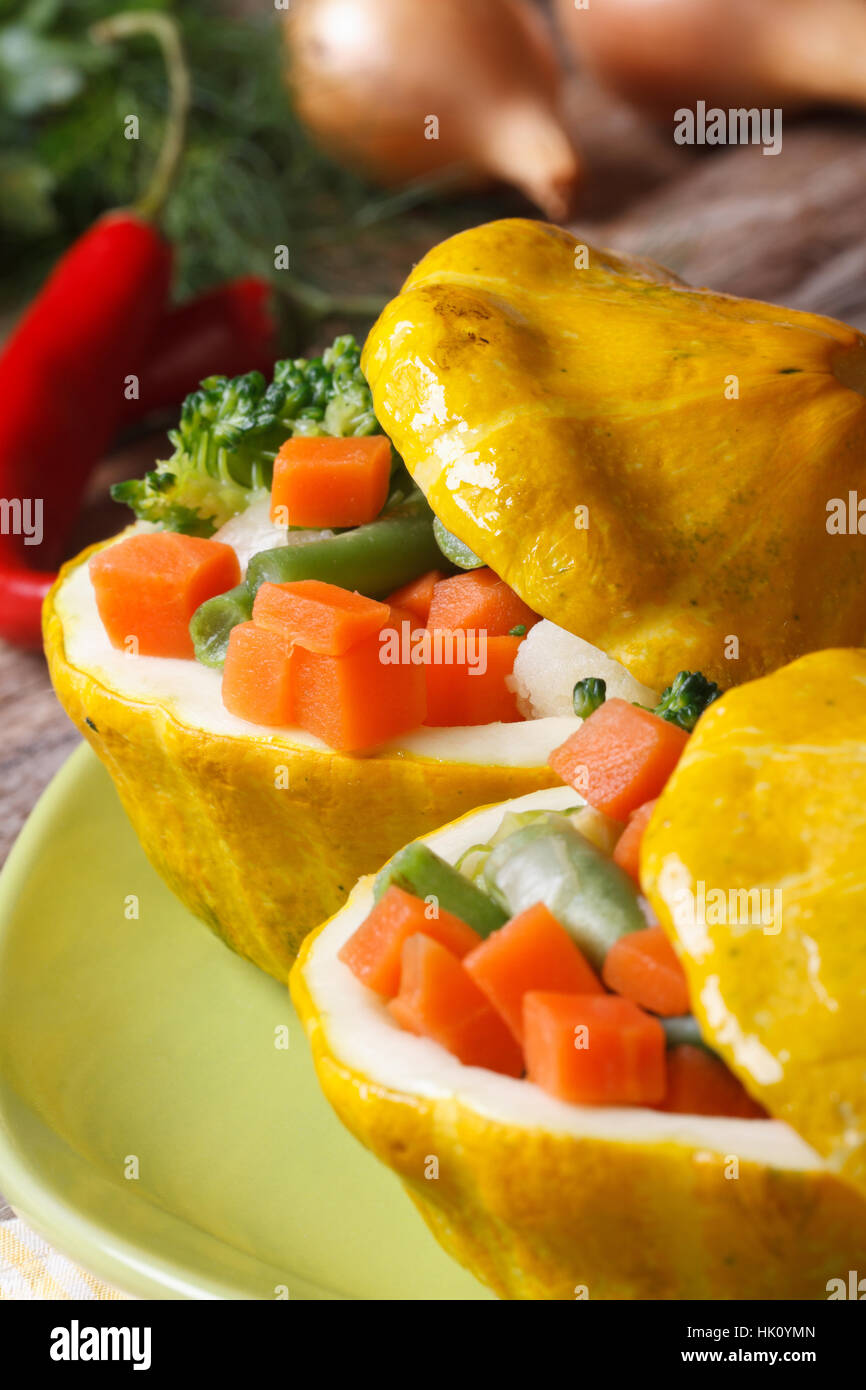 Baked round yellow squash stuffed with vegetables, close-up on the ...