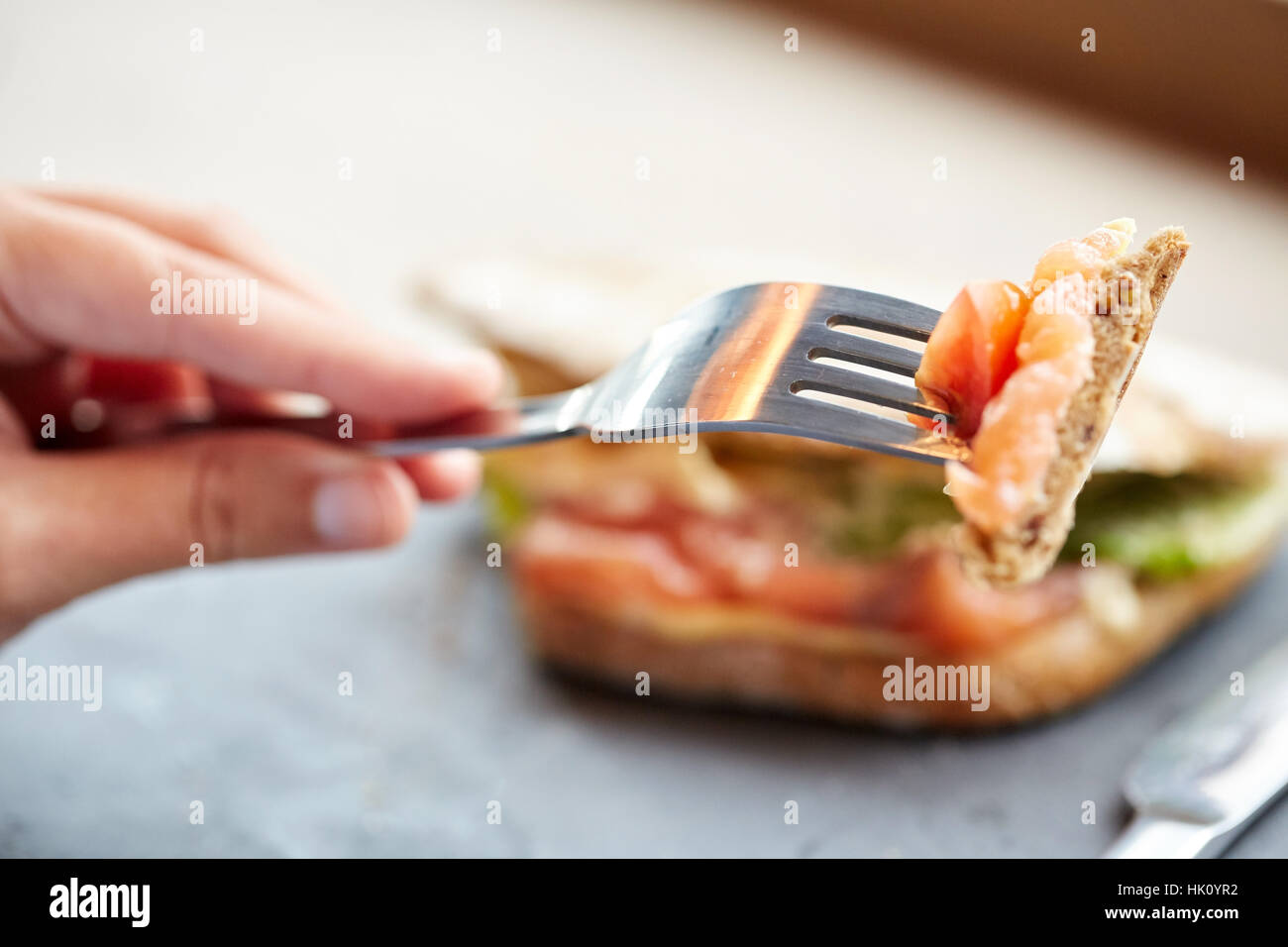 woman eating salmon panini sandwich at restaurant Stock Photo - Alamy