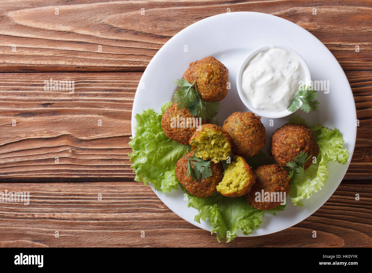 delicious falafel on lettuce with tzatziki sauce close-up view from ...
