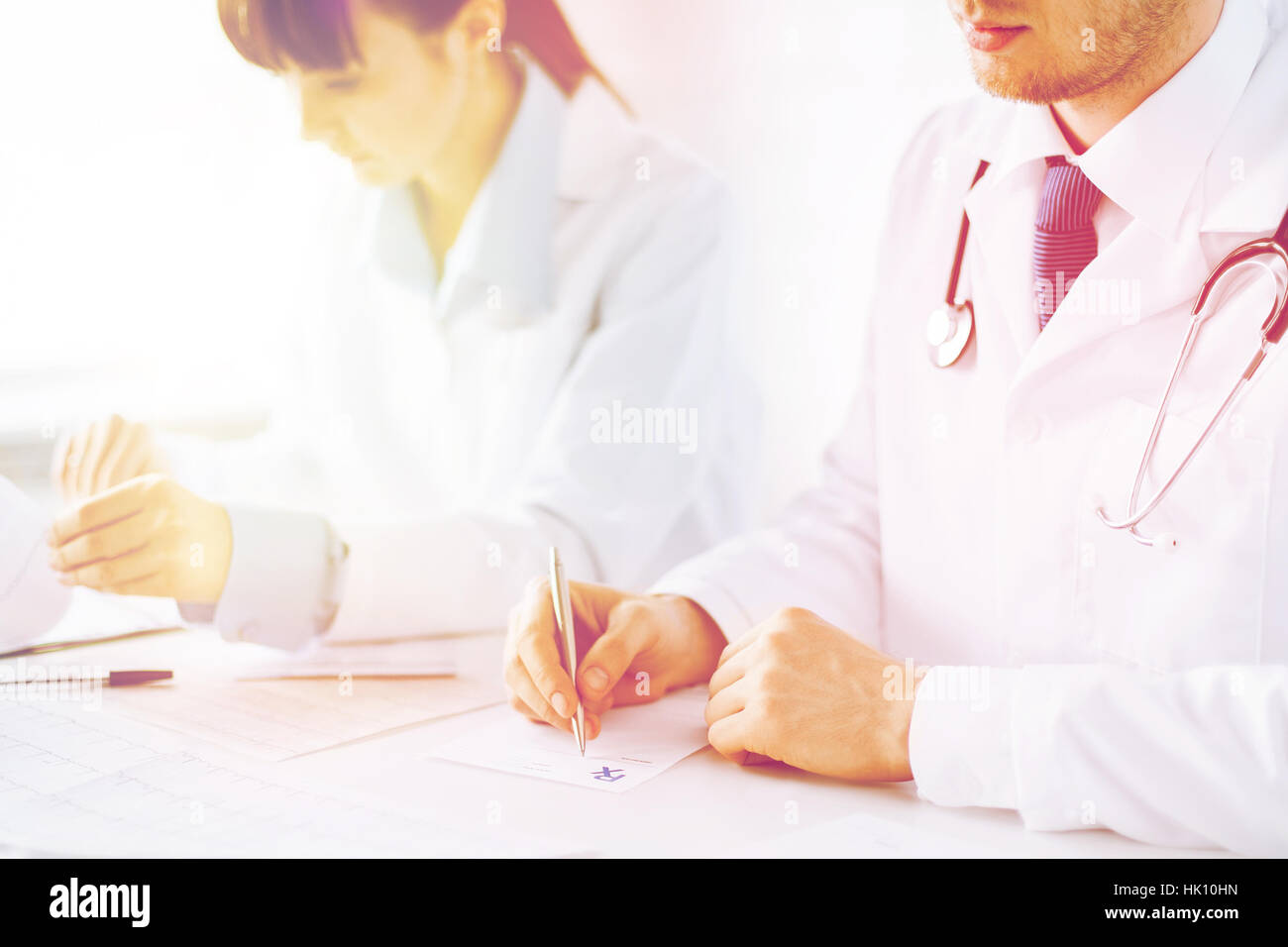 doctor and nurse writing prescription paper Stock Photo - Alamy