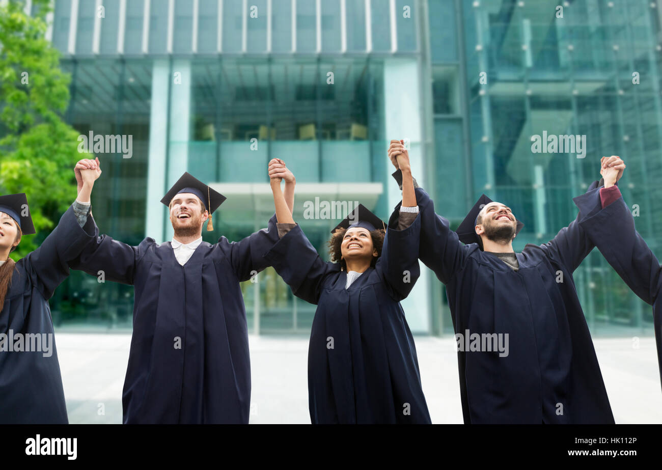 happy students or bachelors celebrating graduation Stock Photo - Alamy