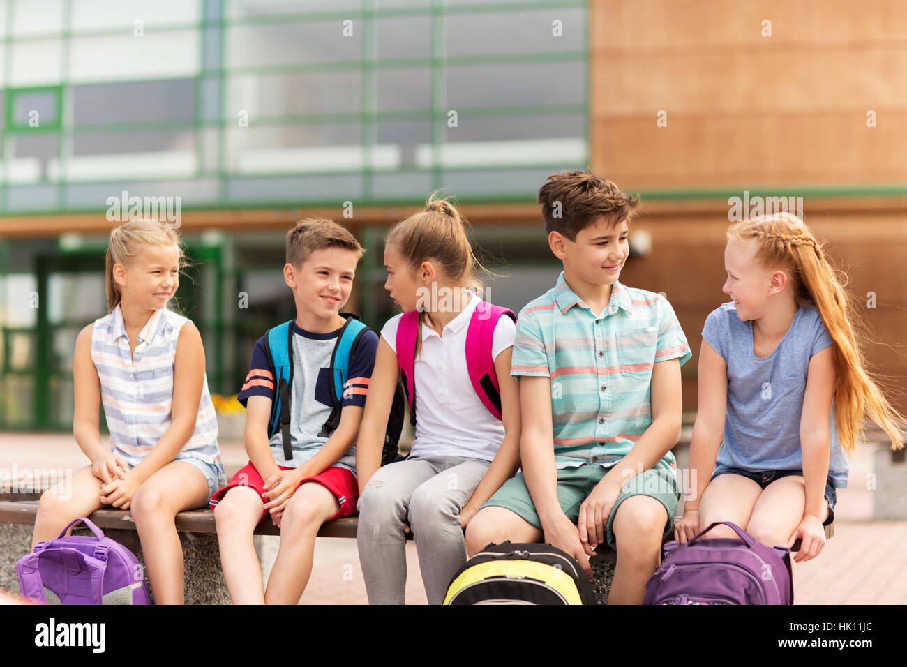 group of happy elementary school students talking Stock Photo - Alamy
