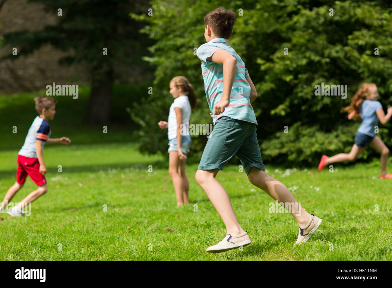 group of happy kids or friends playing outdoors Stock Photo - Alamy