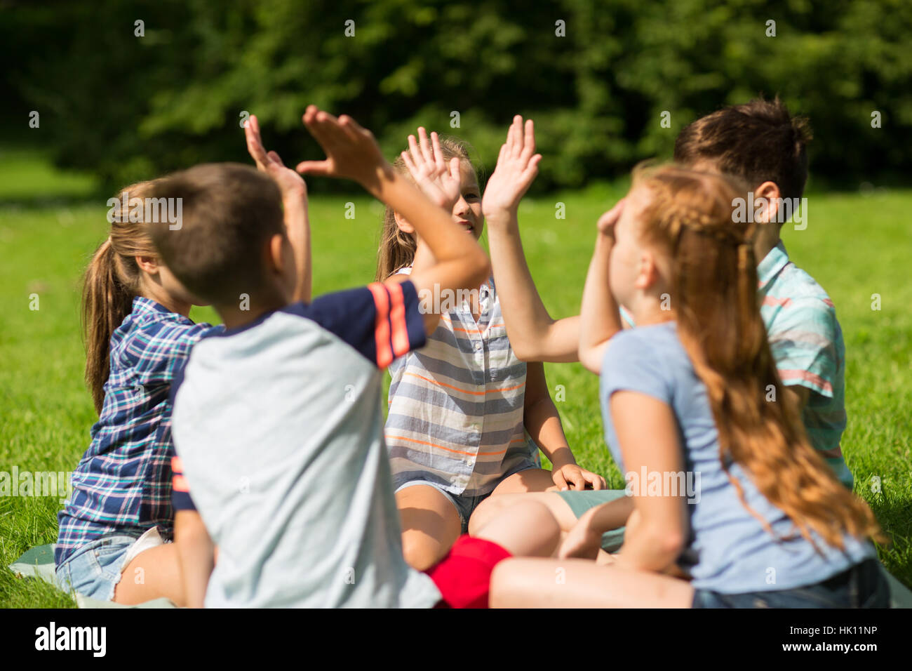 group of happy kids making high five outdoors Stock Photo - Alamy