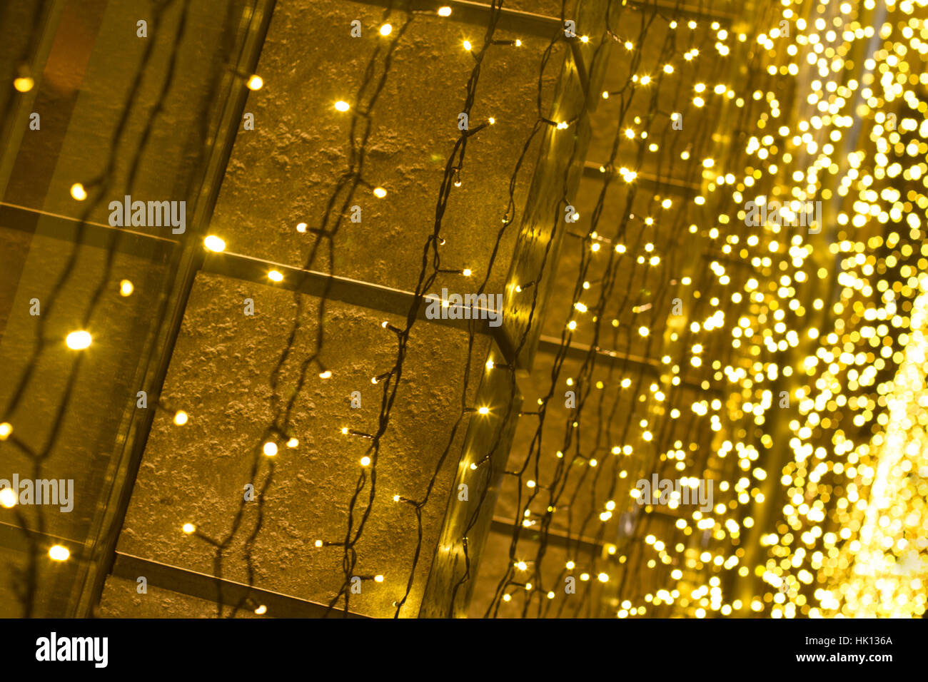 closeup view of night city scene with building wall covered in yellow ...