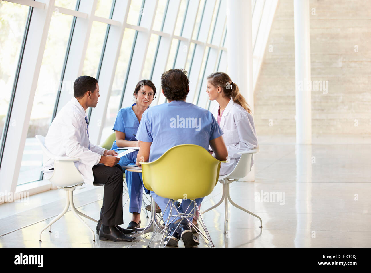 Medical Team Meeting Around Table In Modern Hospital Stock Photo - Alamy